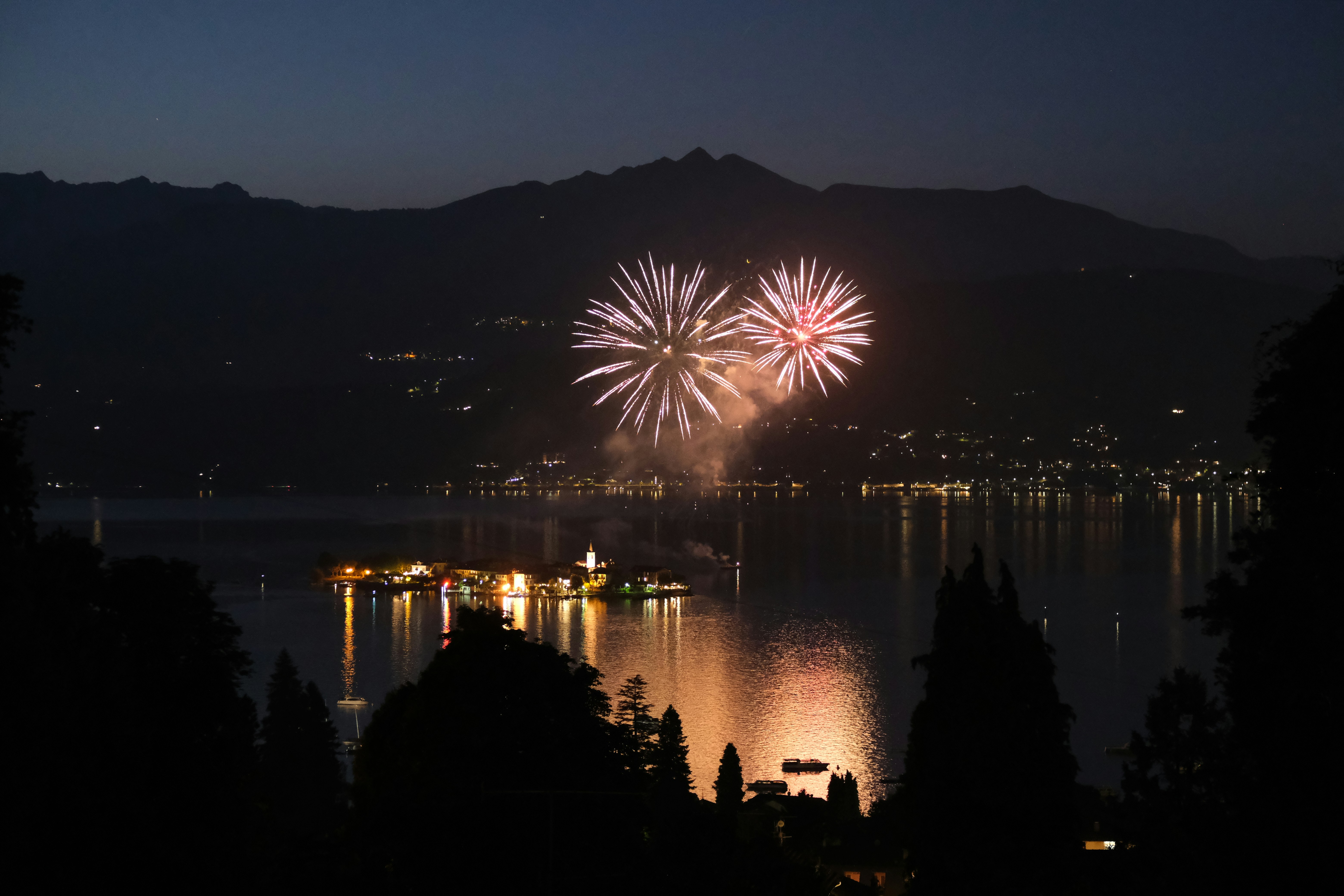 Twin Fireworks Over Quiet Waters