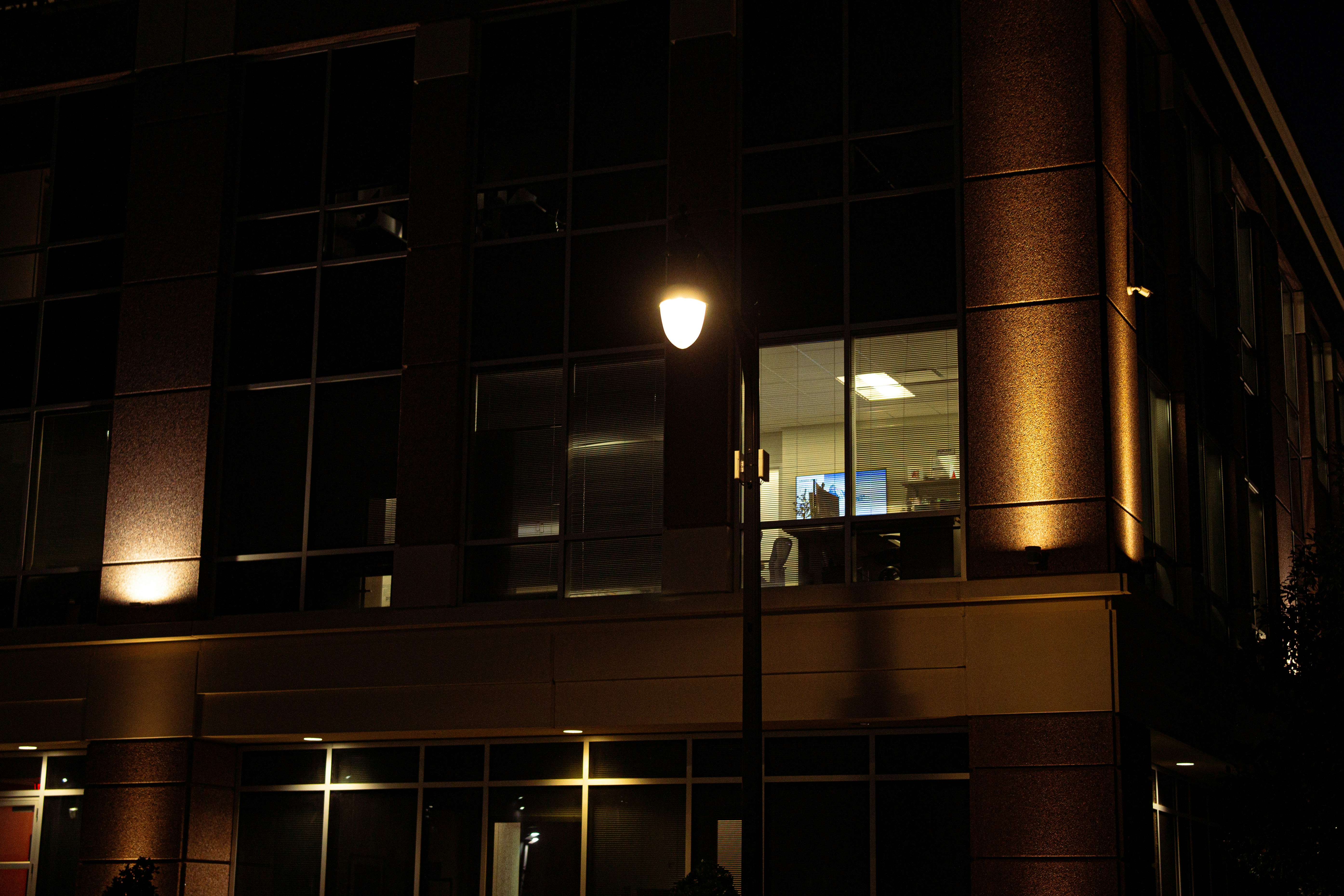 Nighttime Office Facade Illuminated by Streetlamp Glow