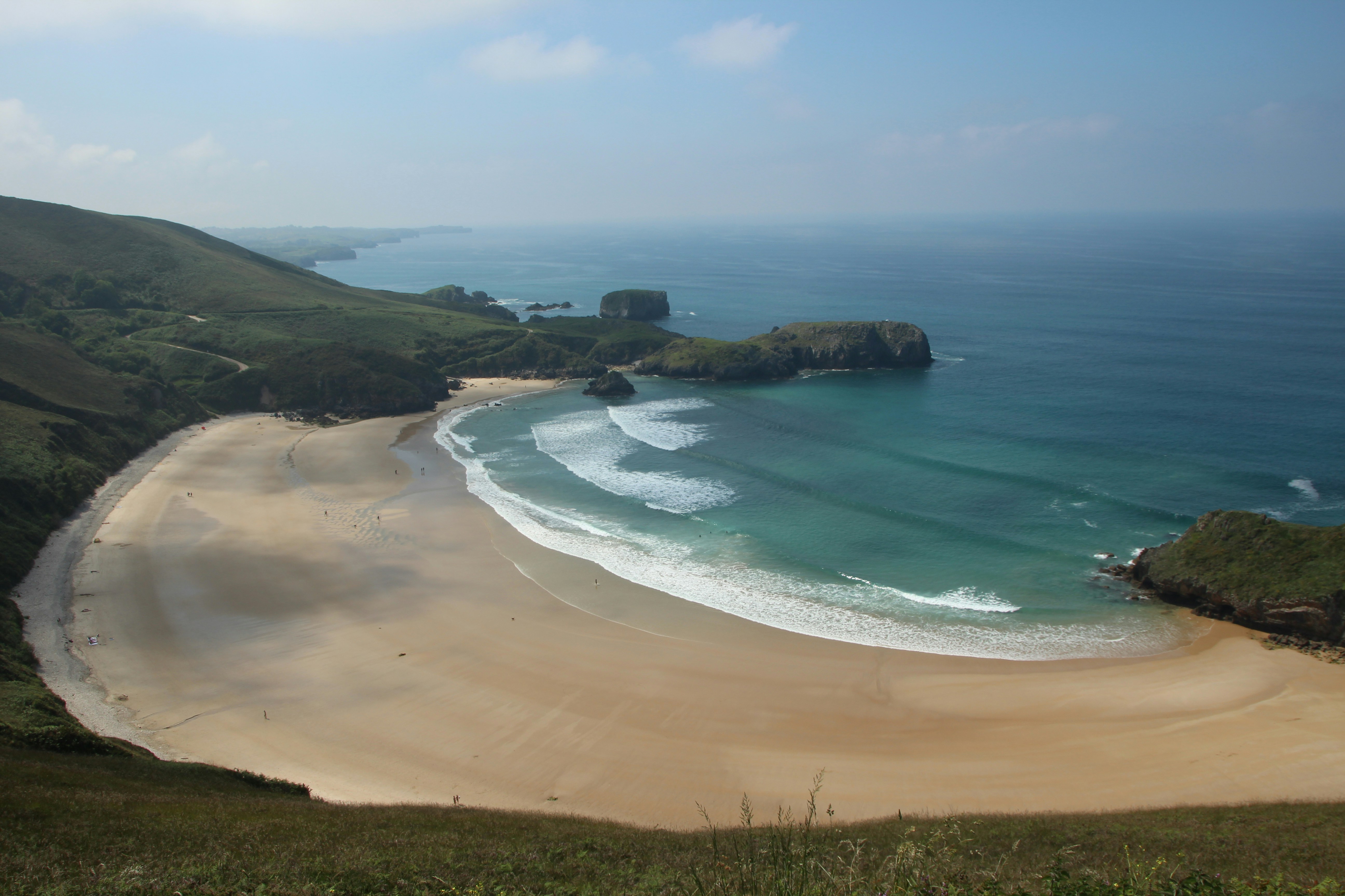 Silent Cove: A Crescent Beach Carved by Sea and Hill