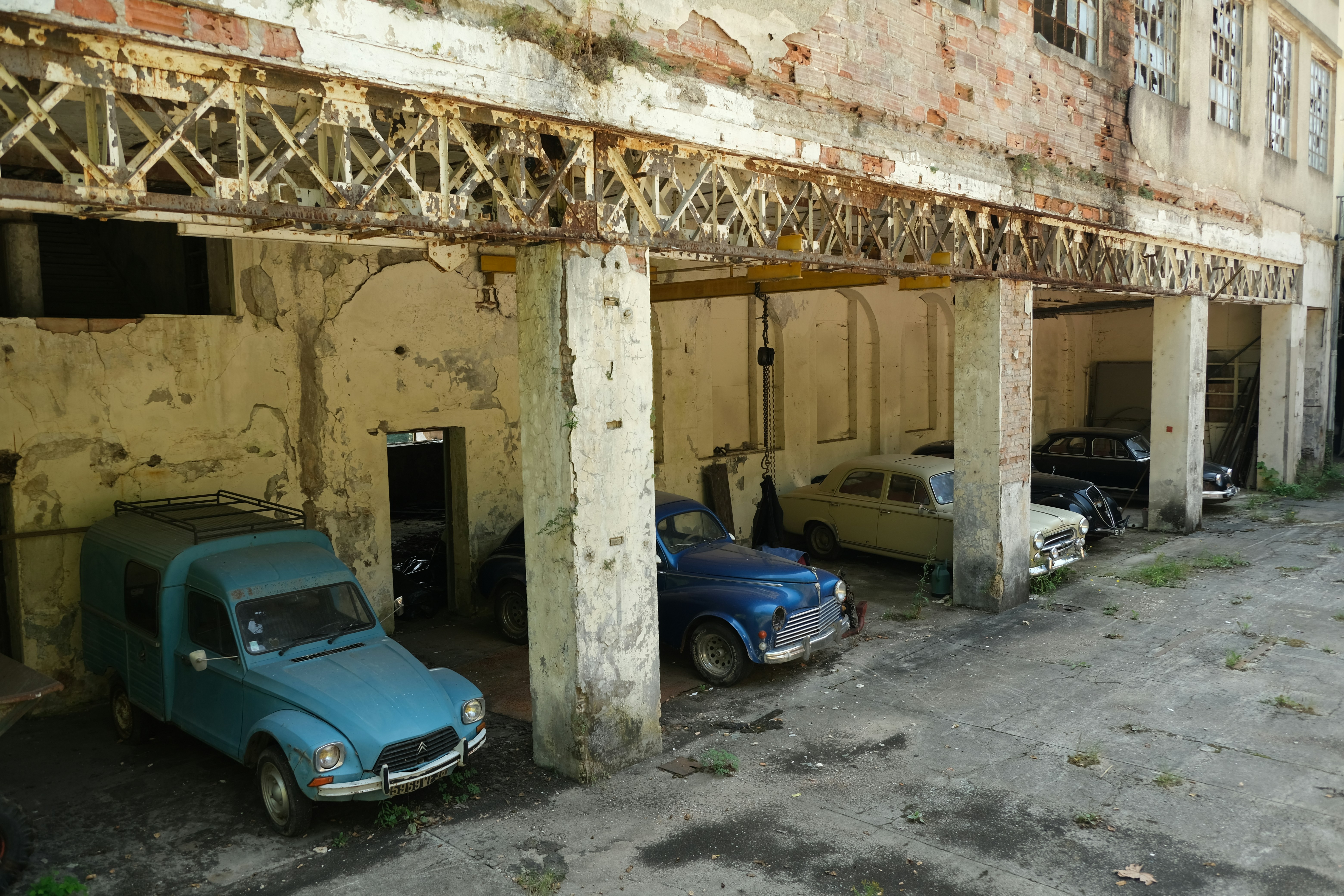 Abandoned Car Gallery under a Weathered Arcade