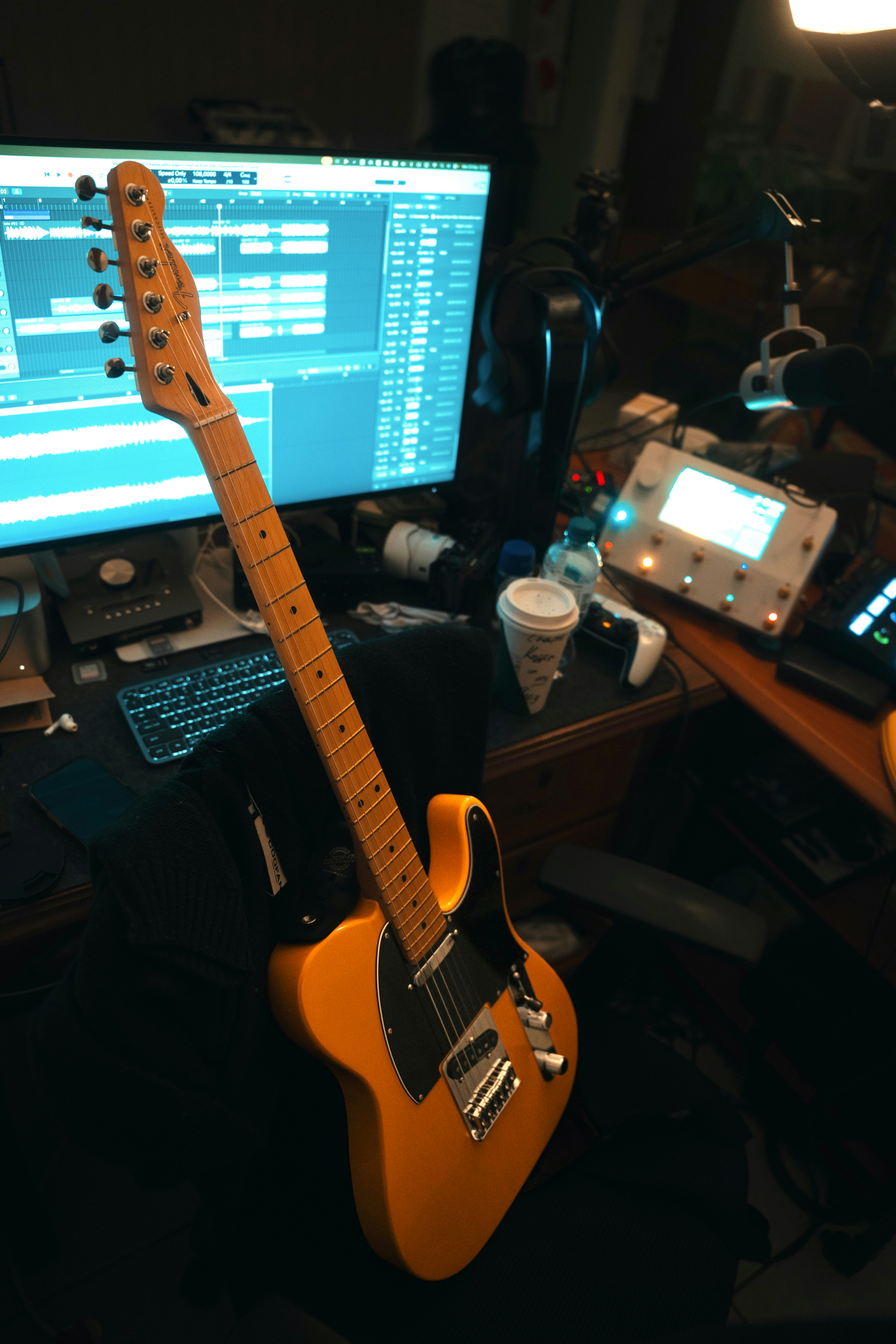 Home Studio Sunrise: A Golden Telecaster Graces the Desk of Creativity