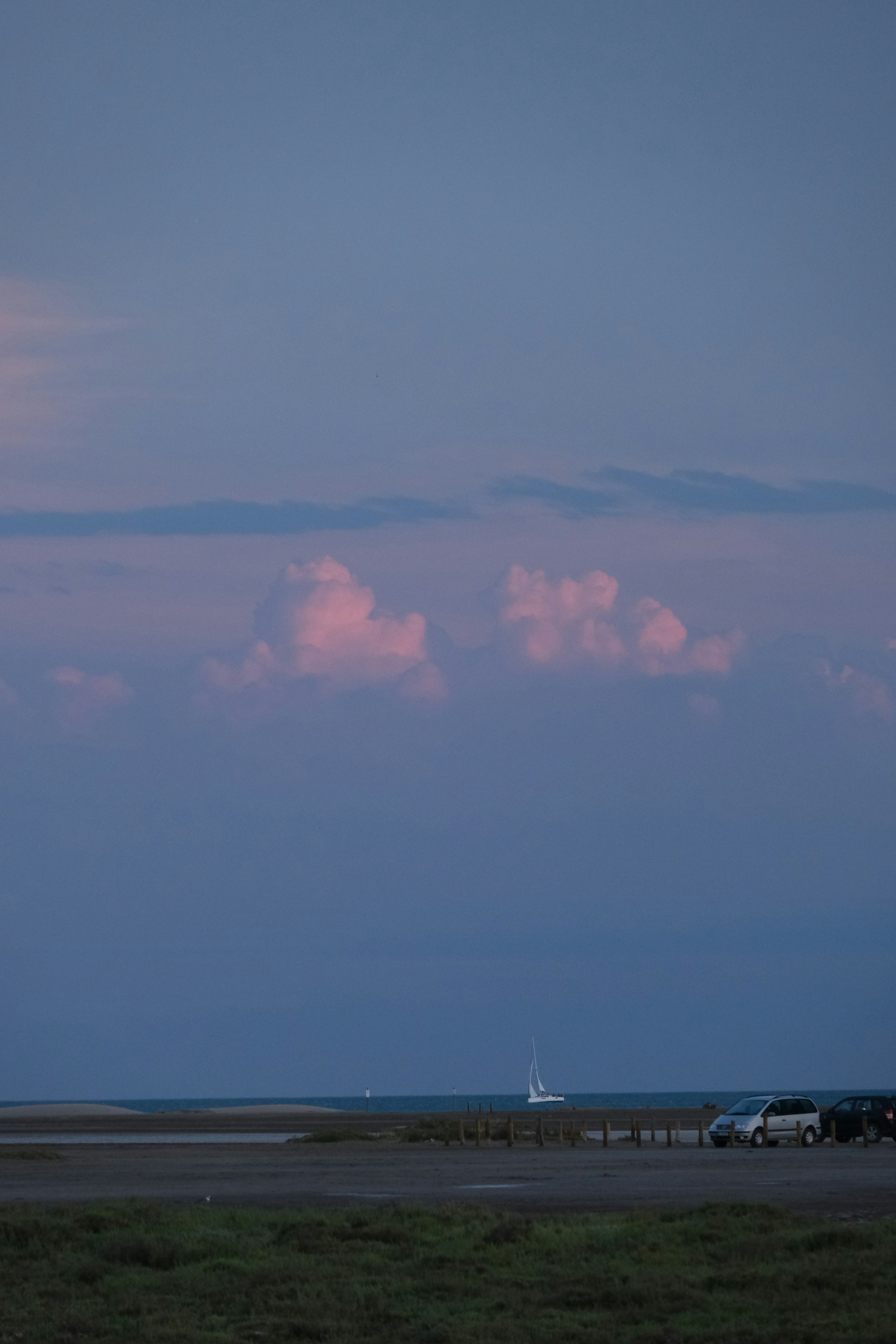 Horizon Quiet: A Distant Sail at Dusk