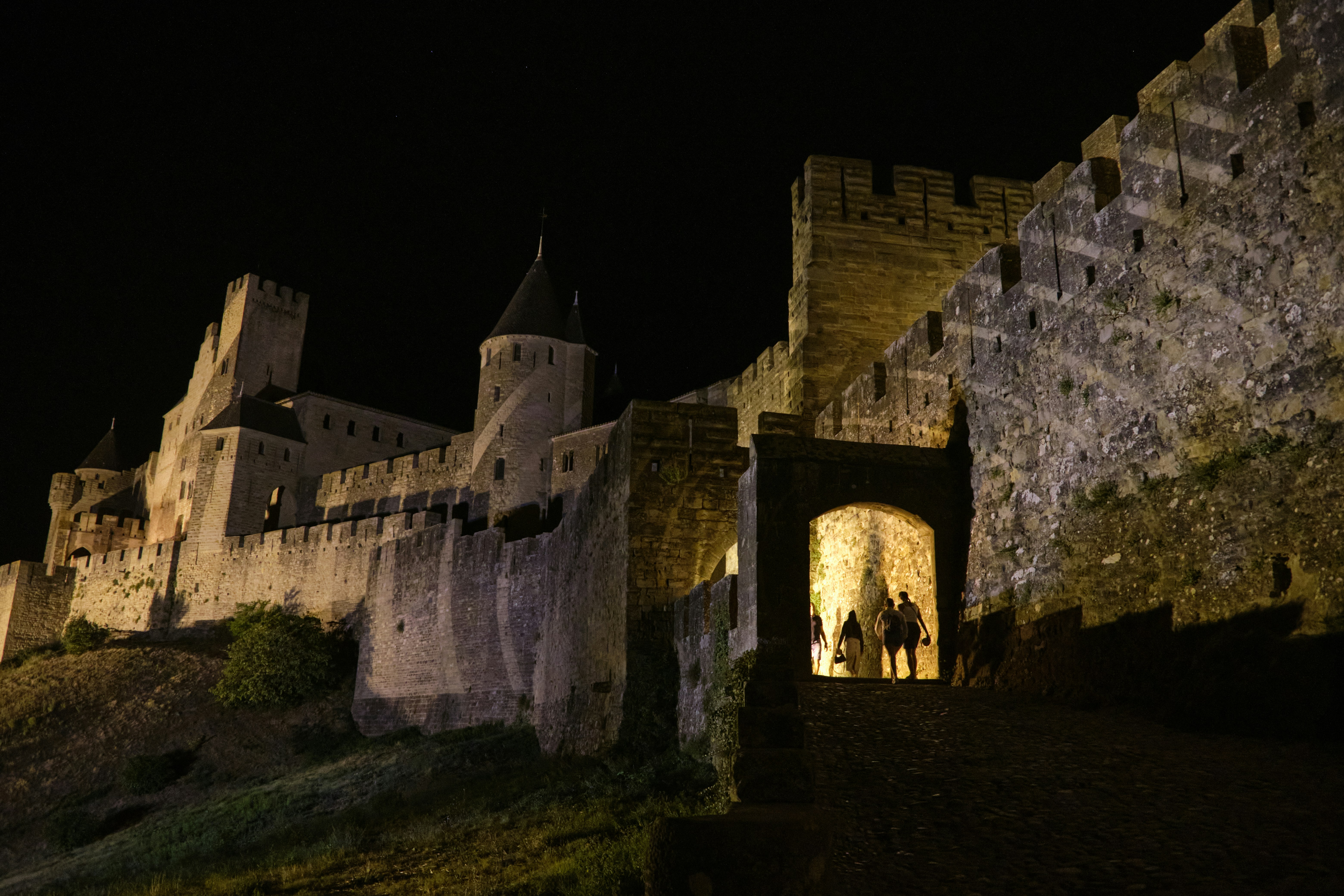 Medieval Gate at Night: Torchlit Welcome into the Citadel