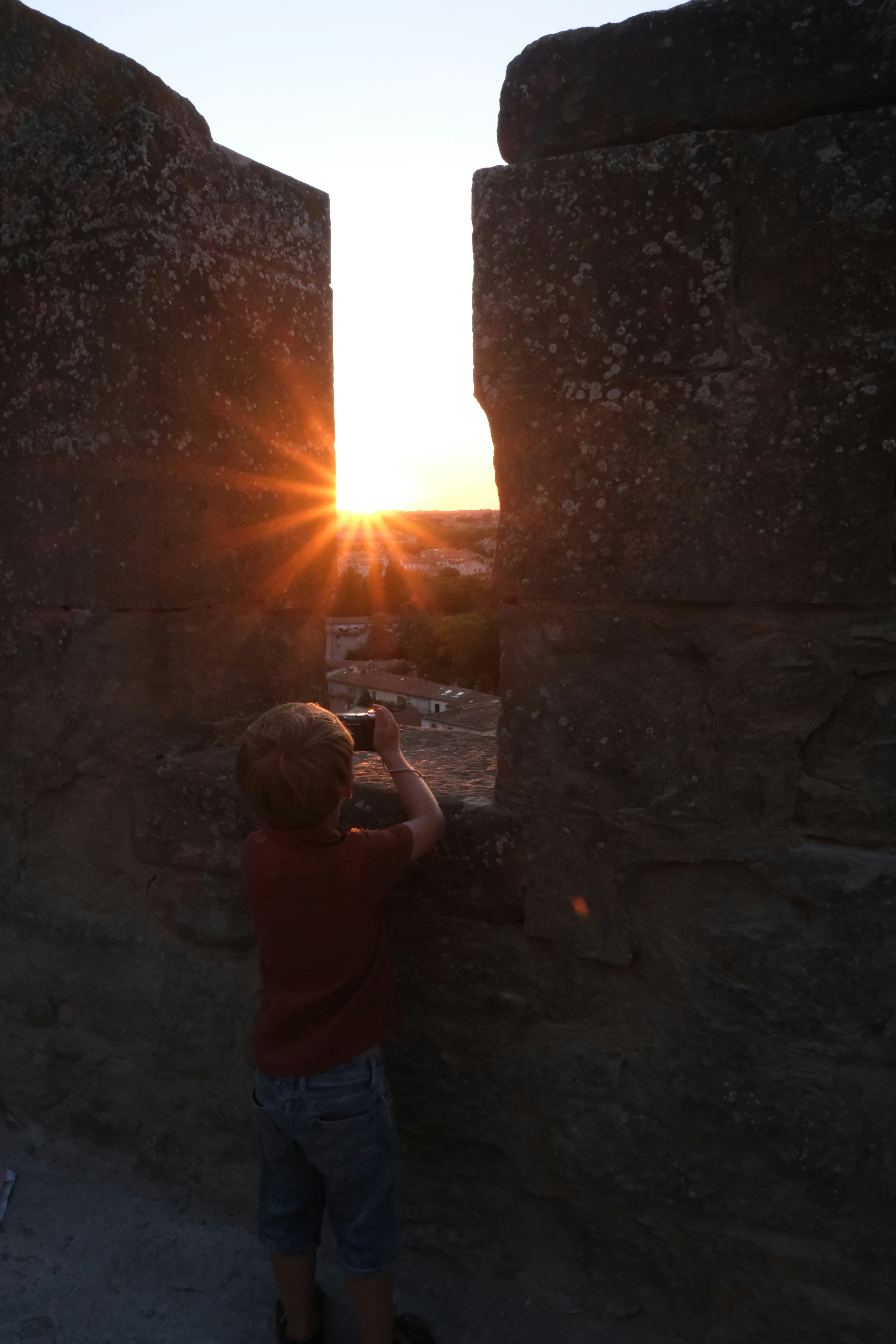 Sunburst Through Ancient Battlements: A Child Captures the Moment