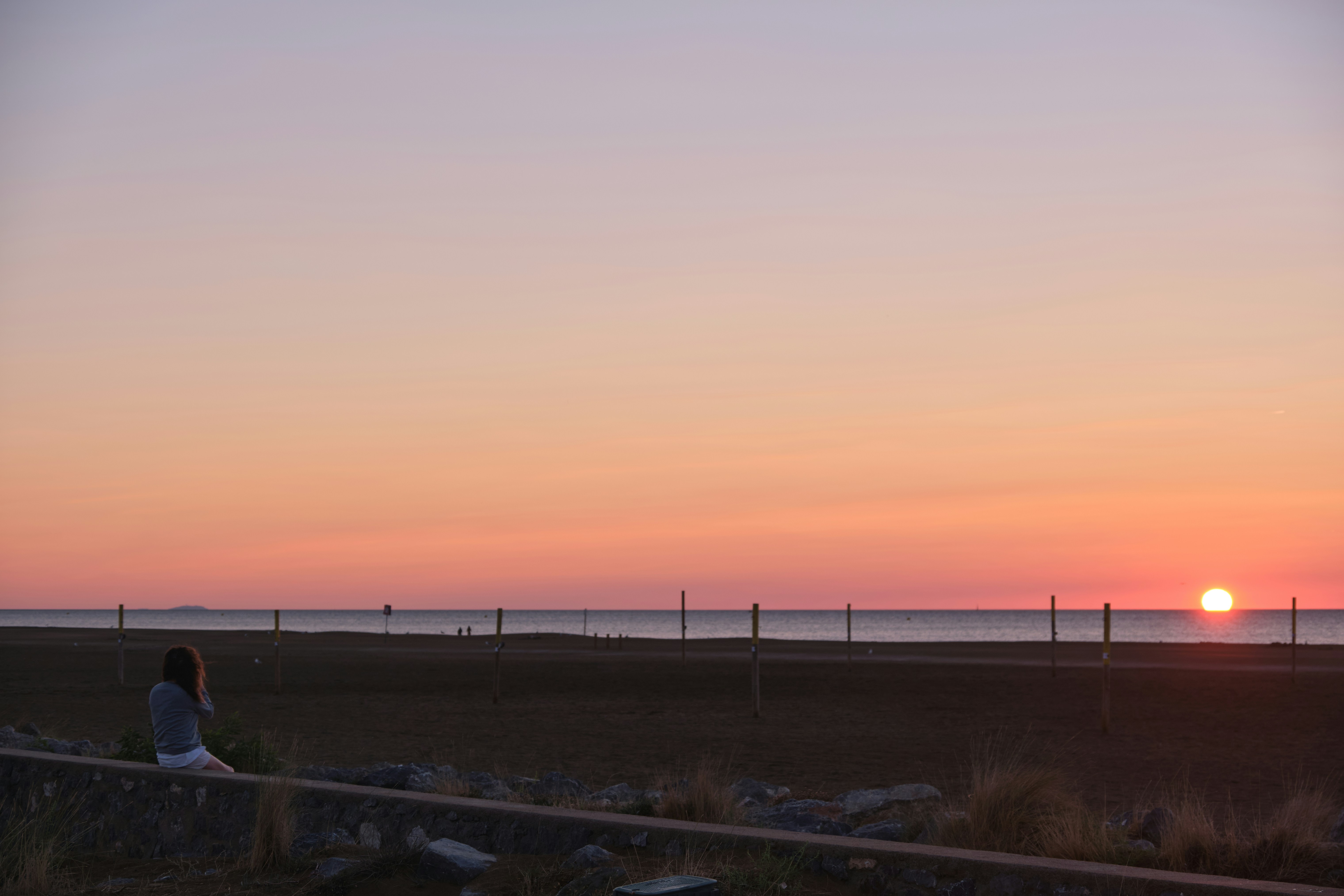 Sunset Bench: Quiet Figure at the Horizon