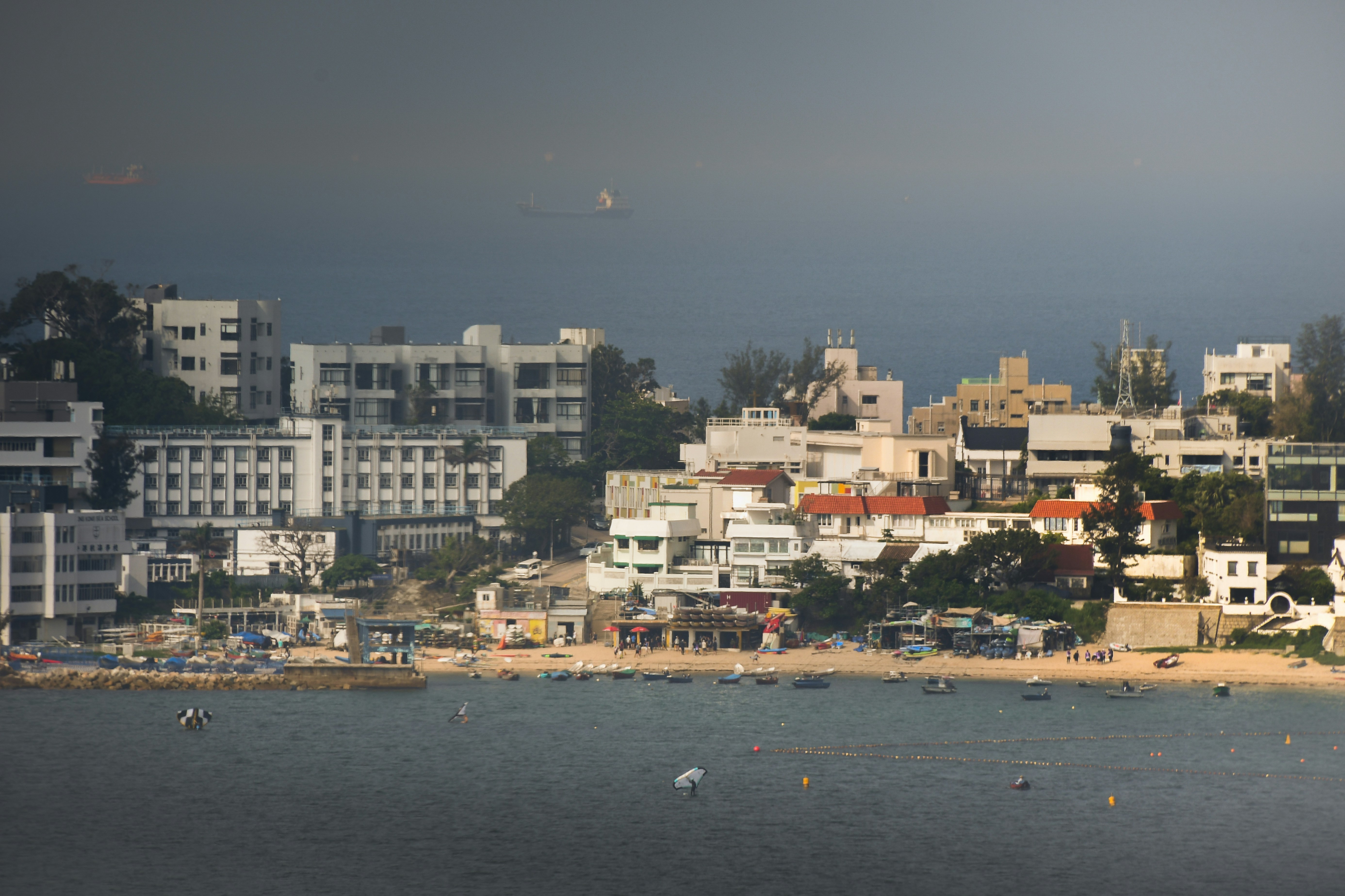 Coastal Town Frontage: Beach, Boats, and Oceanfront Buildings