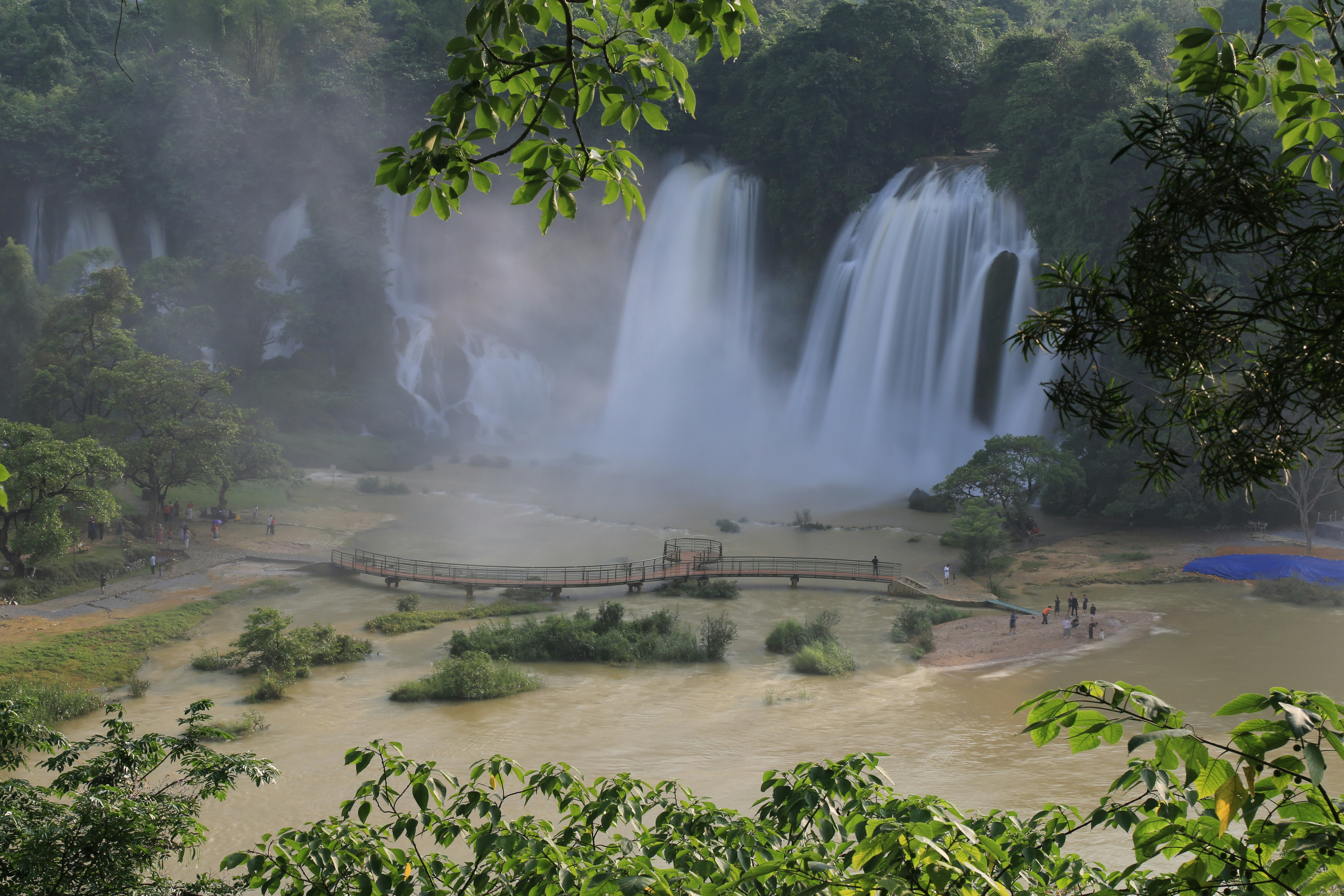 Hanging Veil: A Panoramic View of the Falls Through Framing Foliage