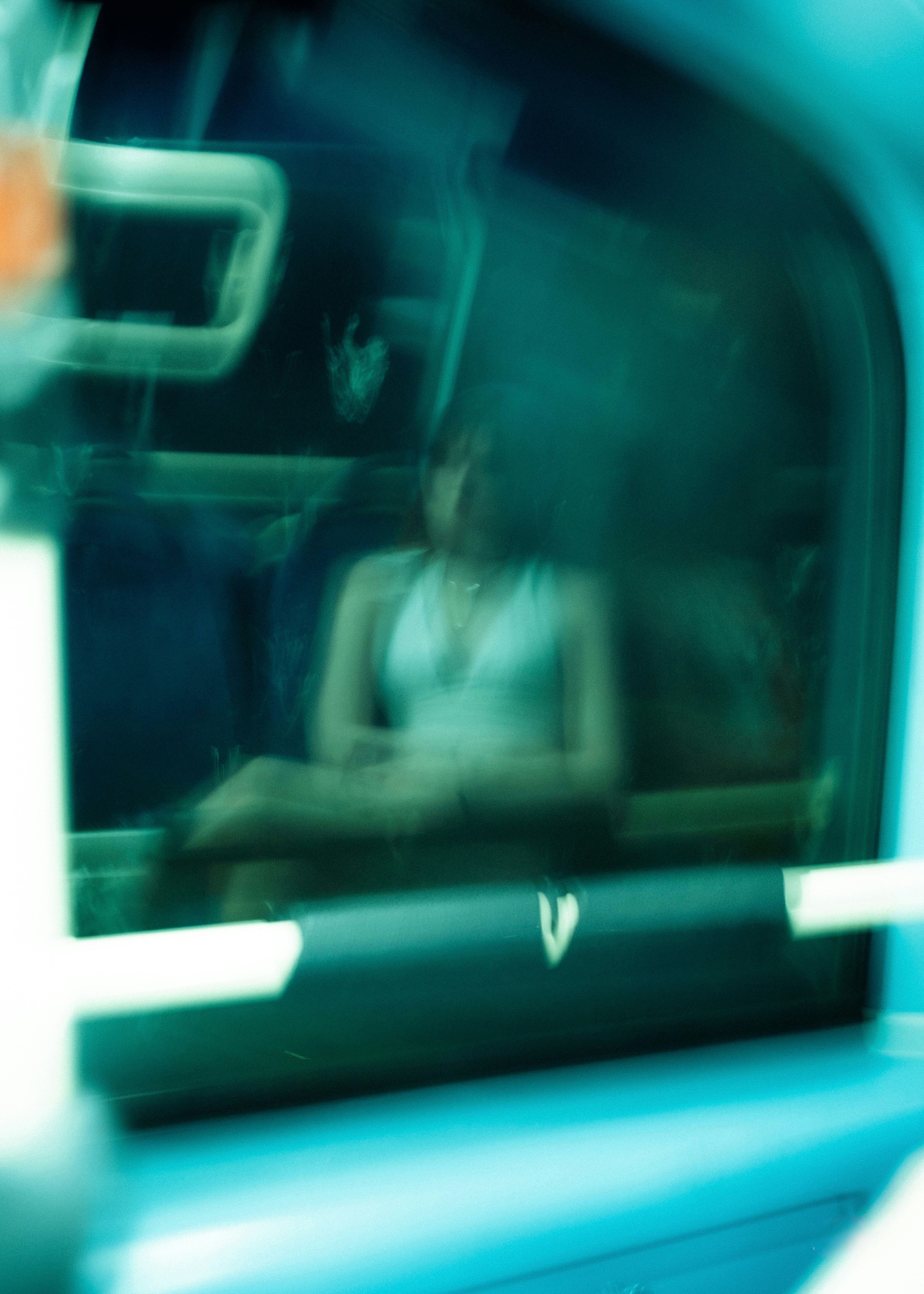 Blurry Portrait in a Train Window: A Quiet Moment of Reflection