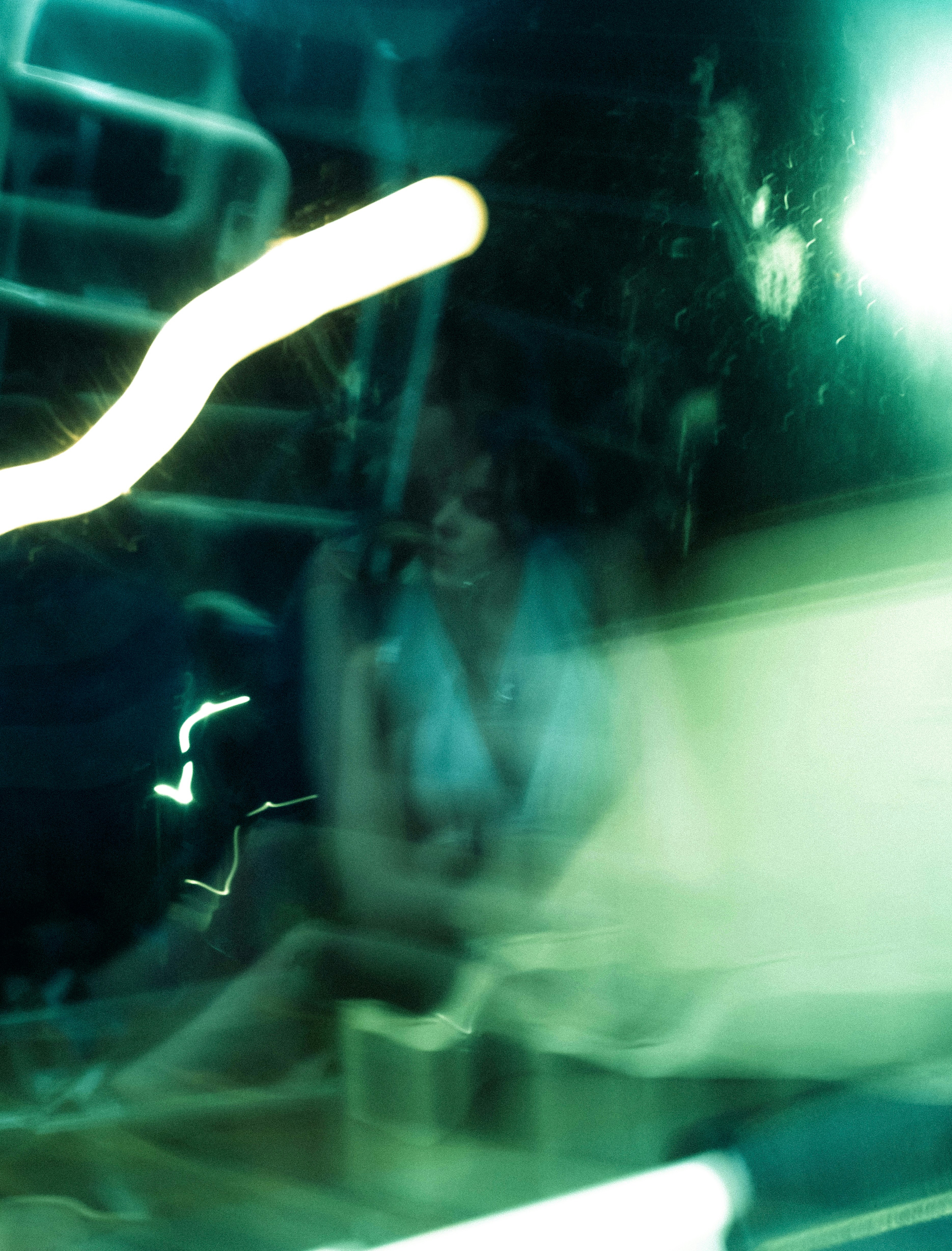 Soft Glare through Green Glass: A Blurred Reflection