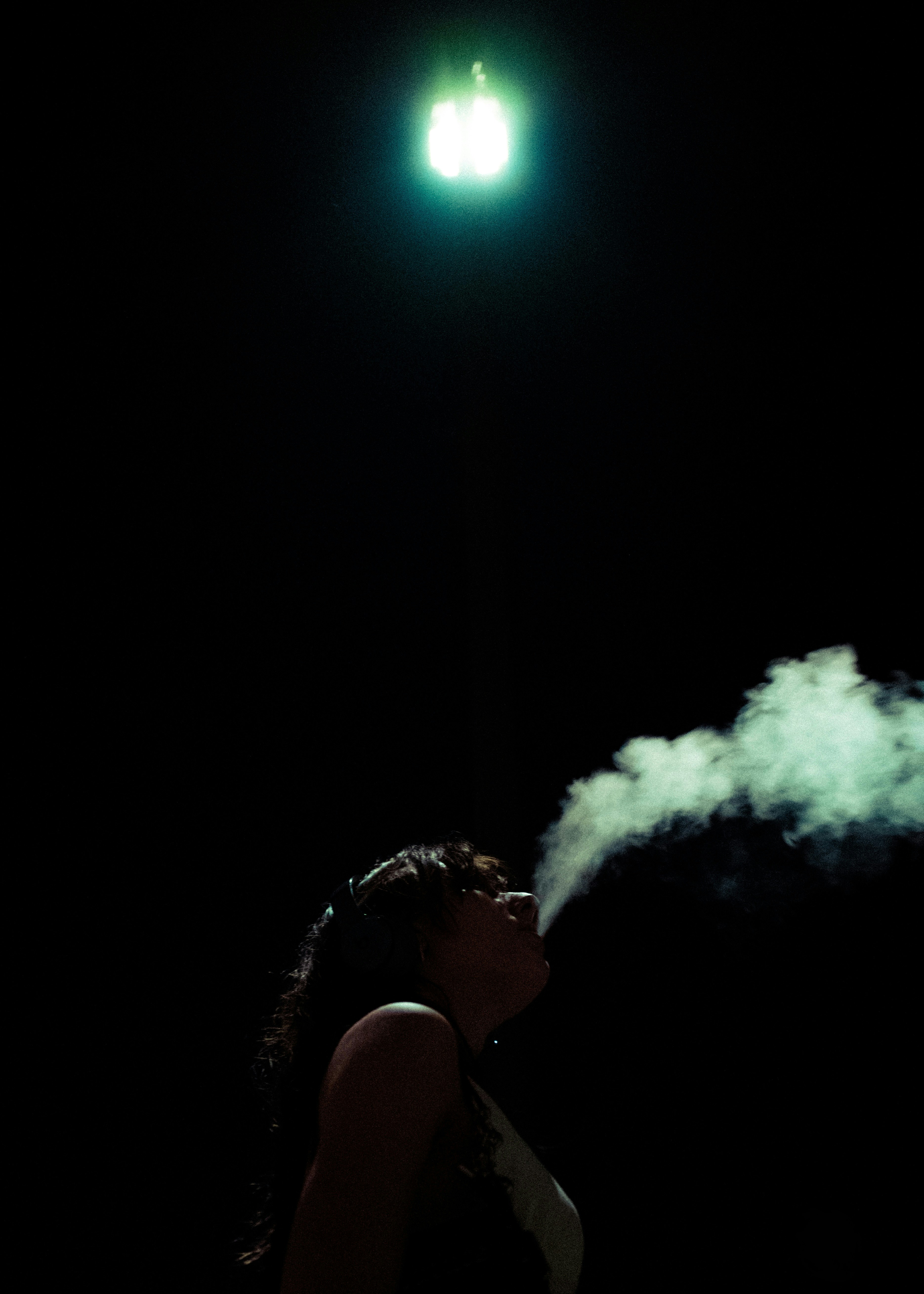 Lone Streetlight and Shadowed Figure: Night Breath Under Neon Sky