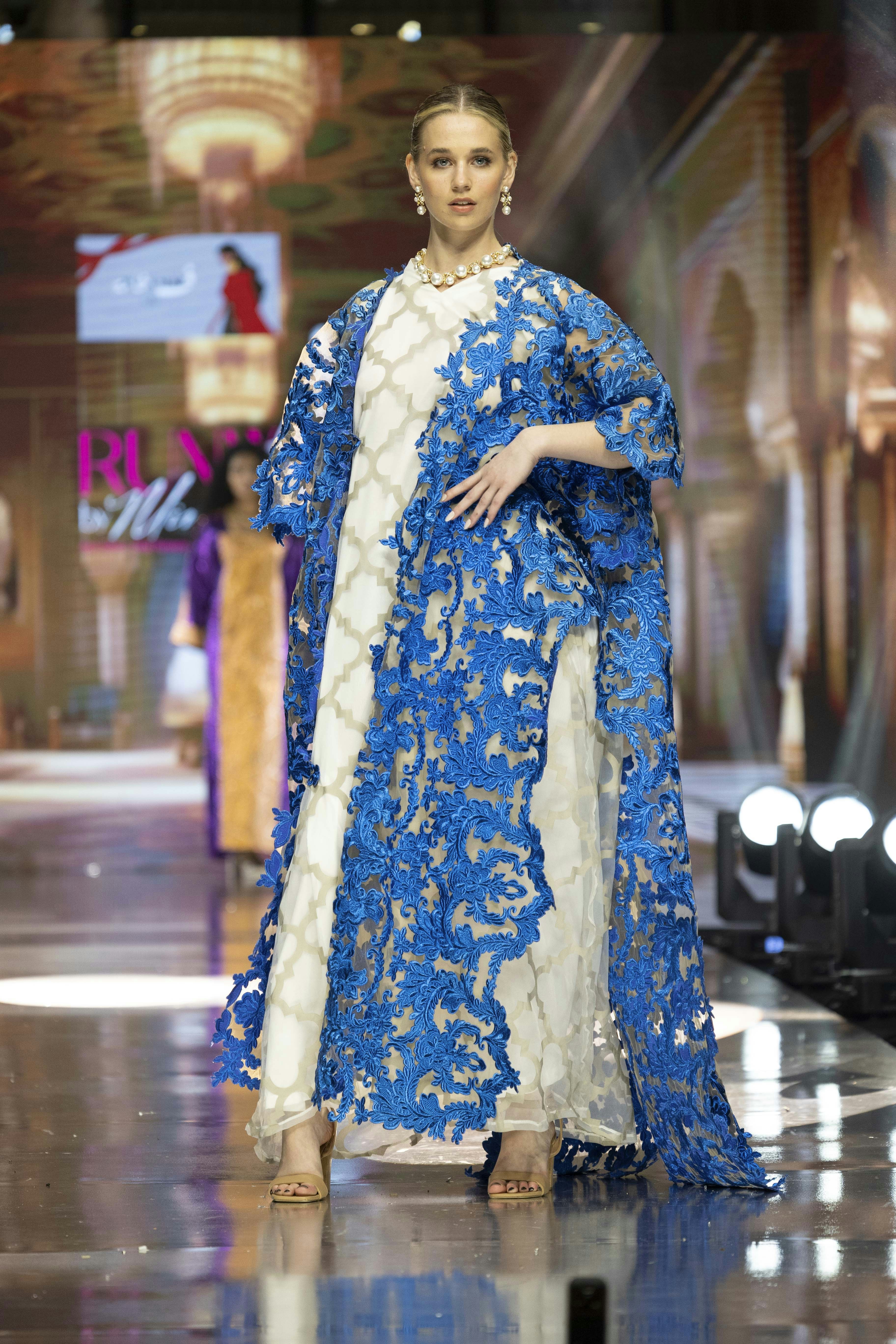 Emerald Veil: A Model in Blue Lace on the Runway