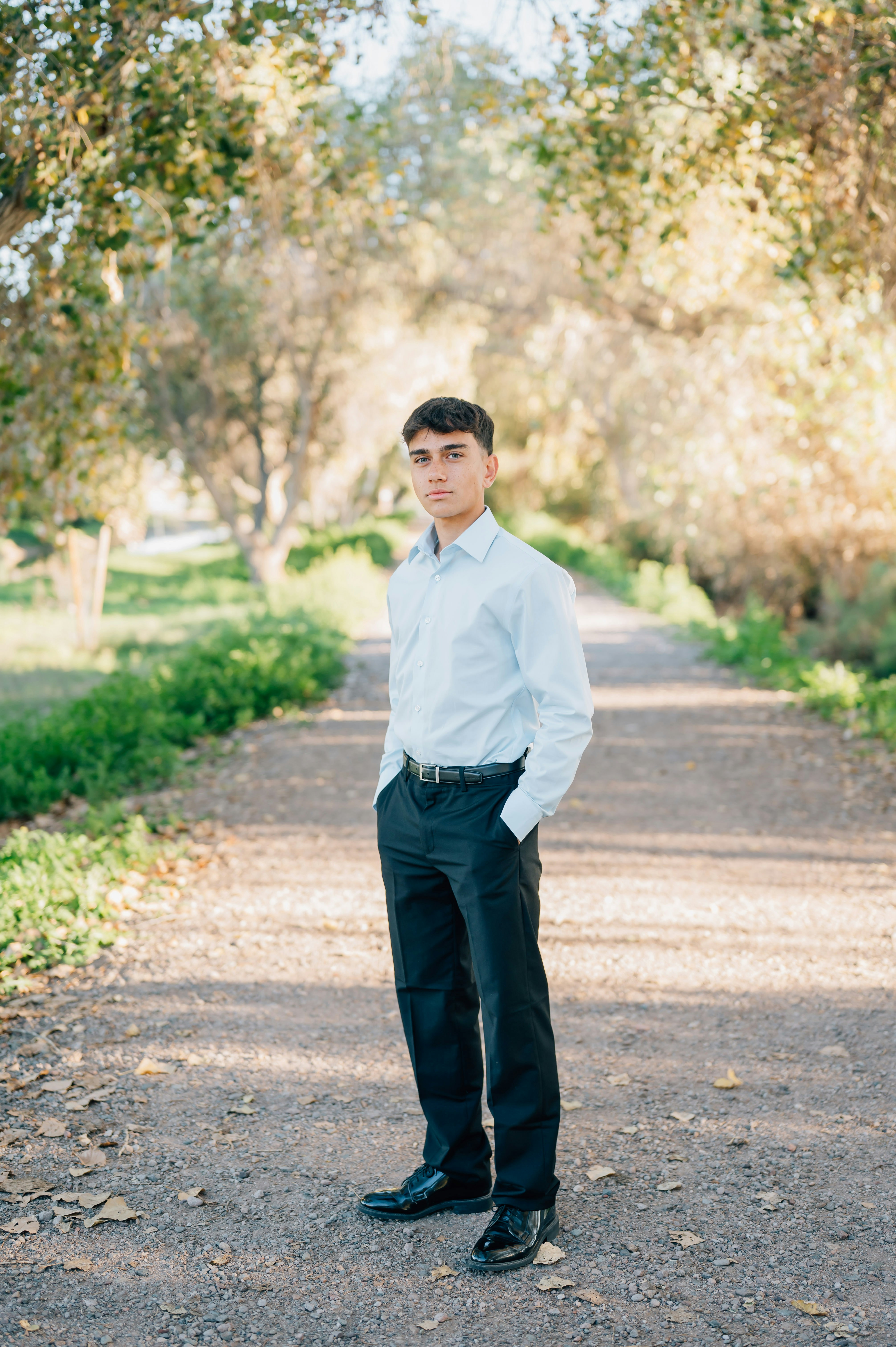 A Quiet Pathway: Portrait in a Sunlit Autumn Park