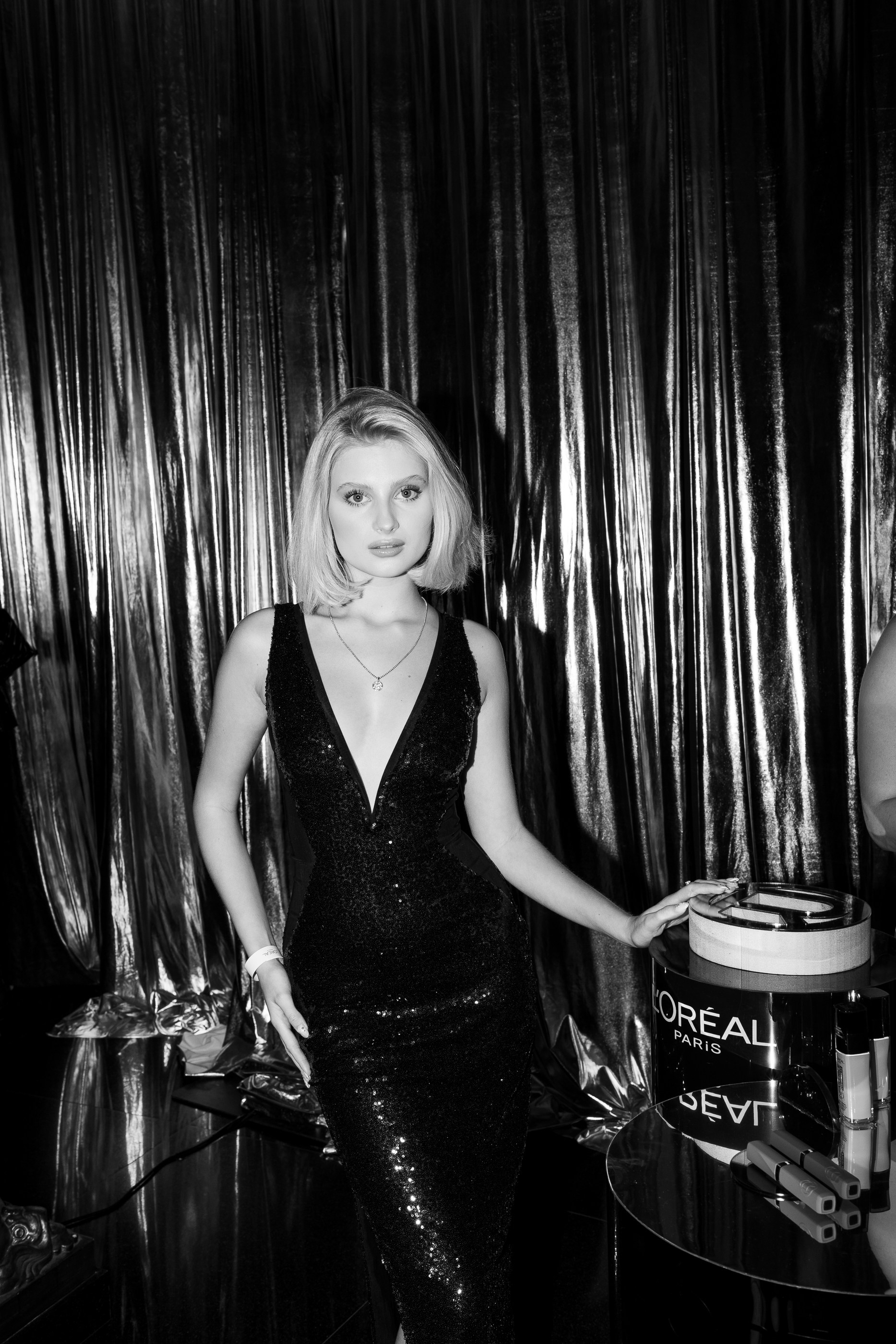 Glamour at the Curtain: A Portrait by the Neon Backdrop