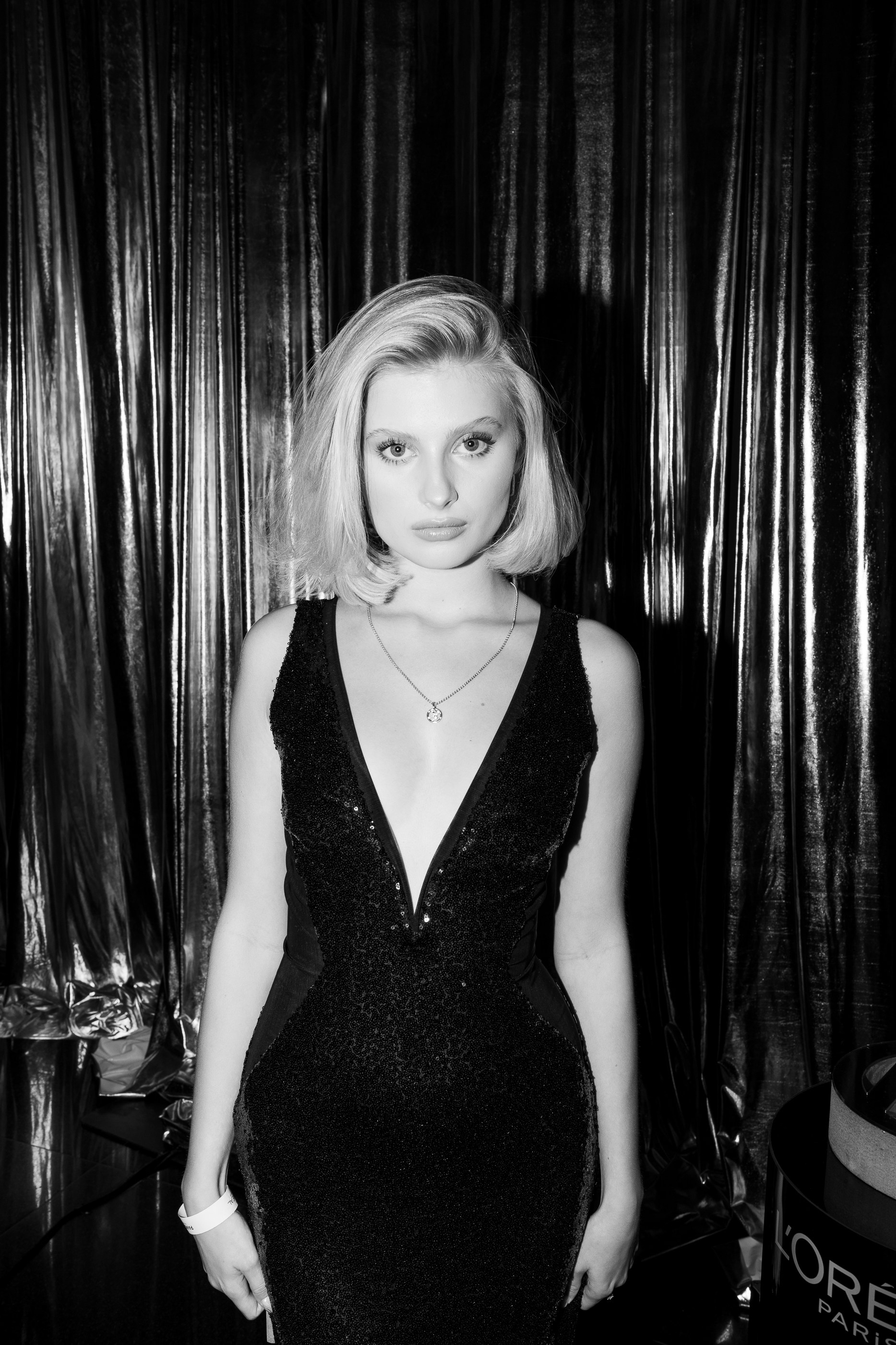 Midnight Velvet: A Poised Portrait Against Dark Drapery
