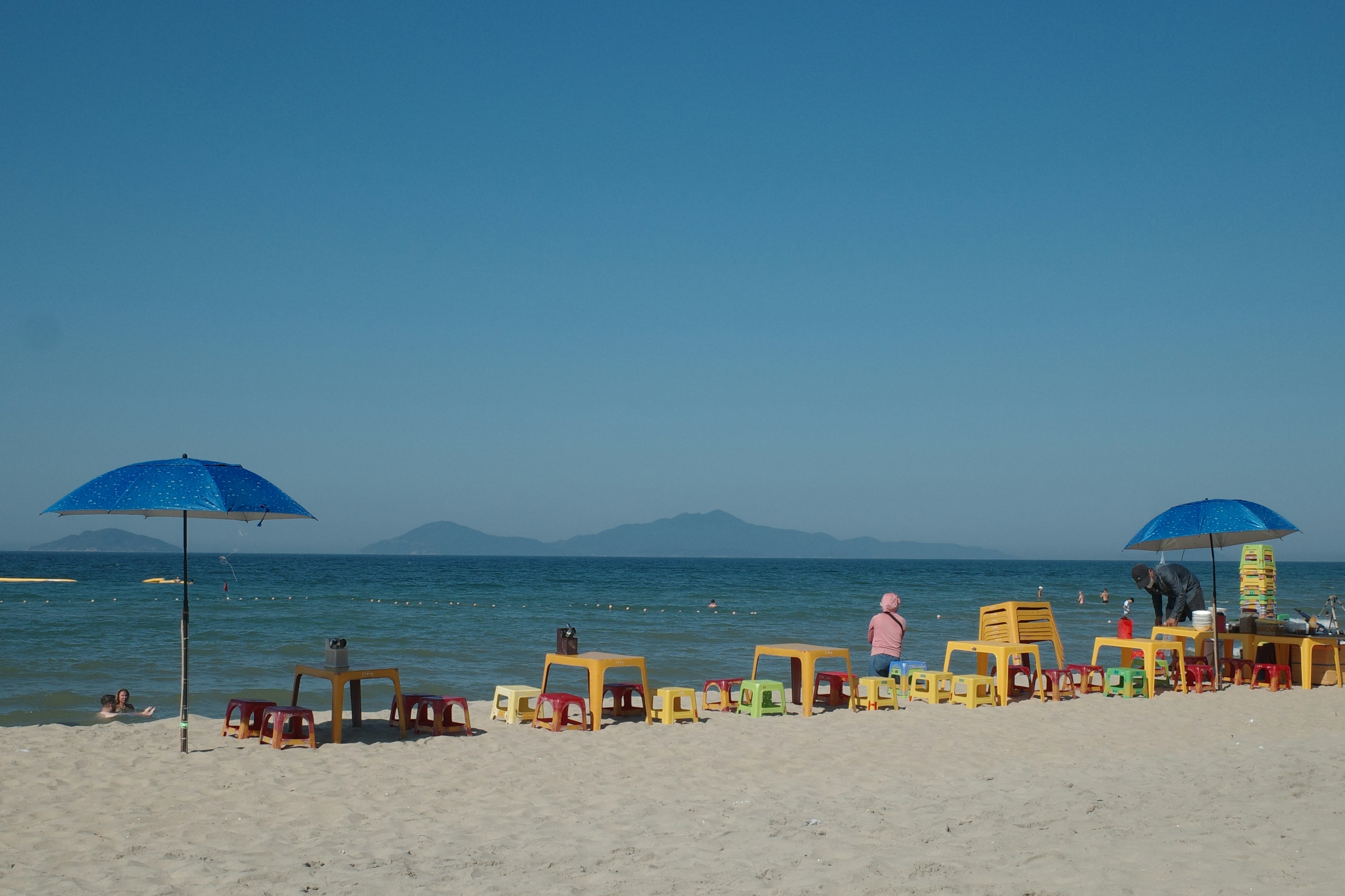 Sunlit Beach Chairs and Umbrellas Along a Calm Sea