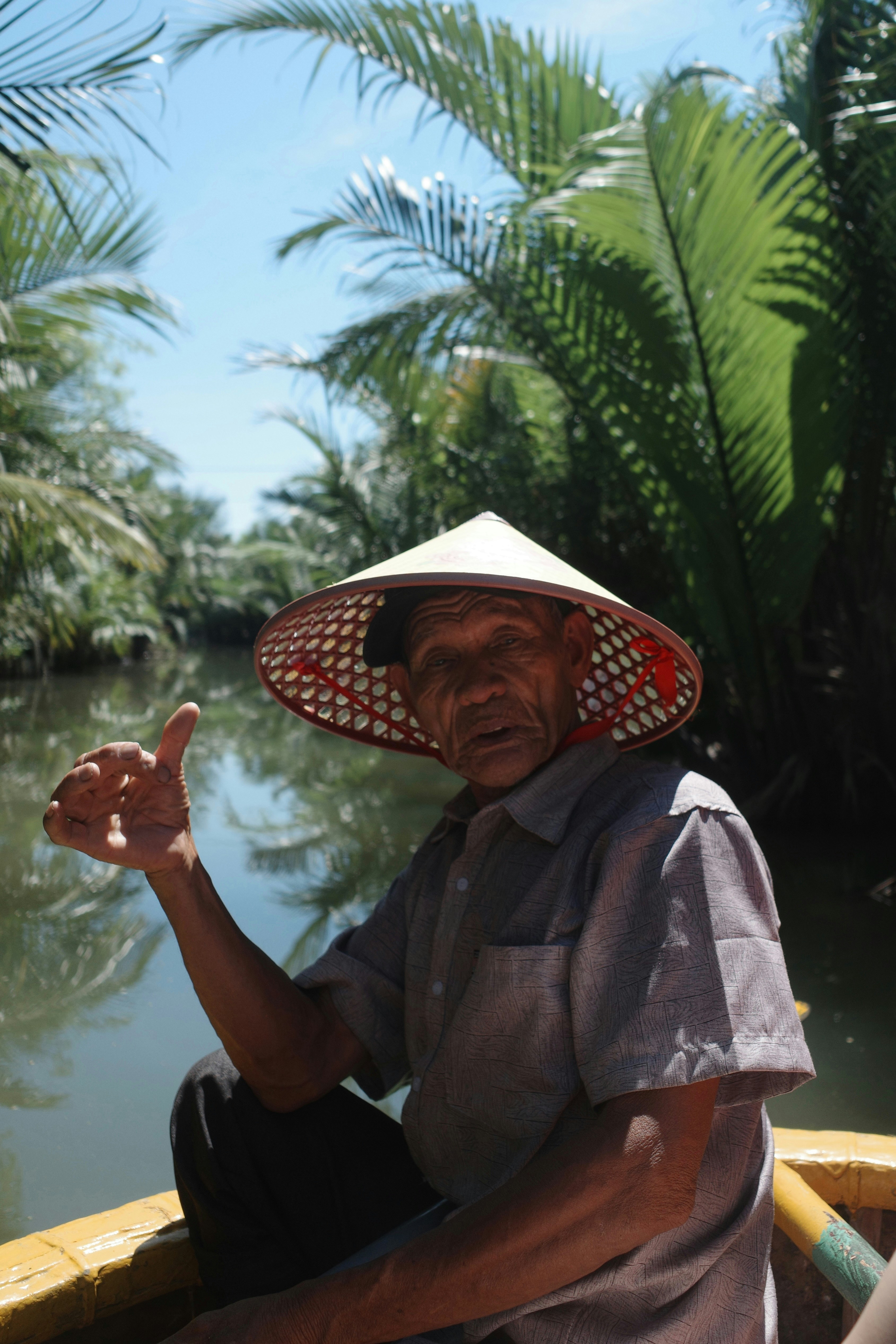 River Tips and Warm Light: Portrait of a Boatsman in a Tropical Canal