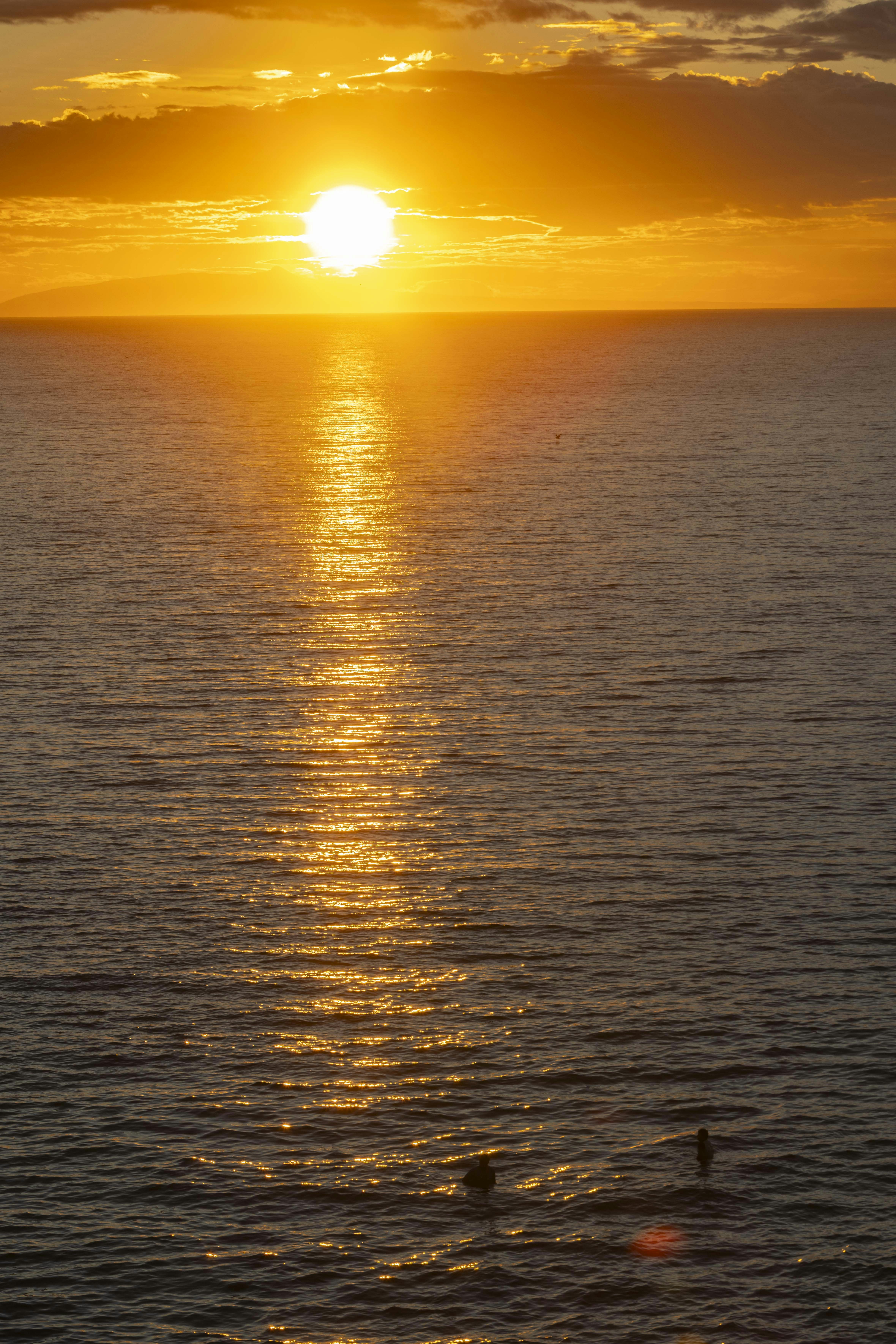 Gilded Horizon: Sunlit Sea and Silhouettes at Dusk