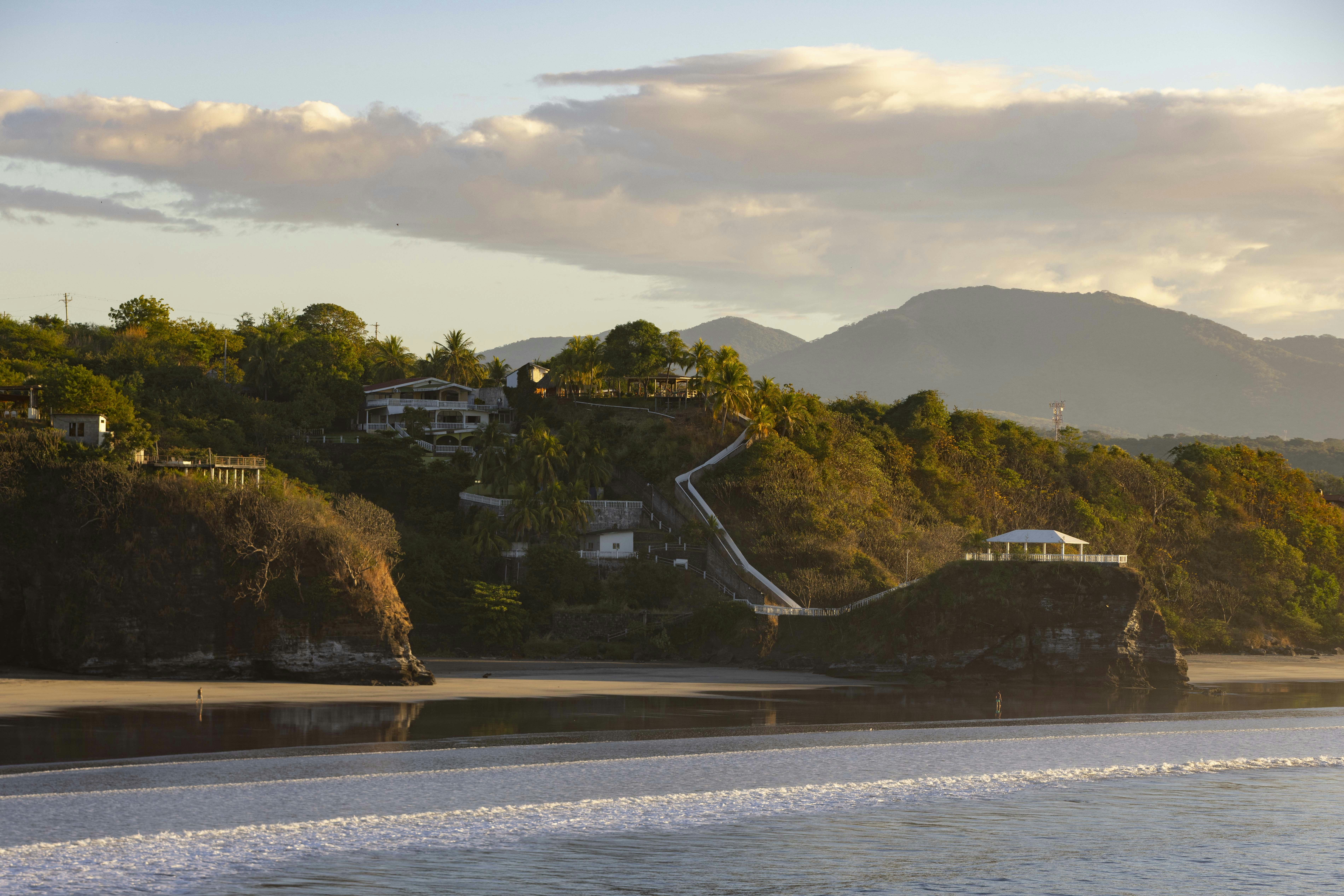 Coastal hillside retreat hugging the shore at golden hour