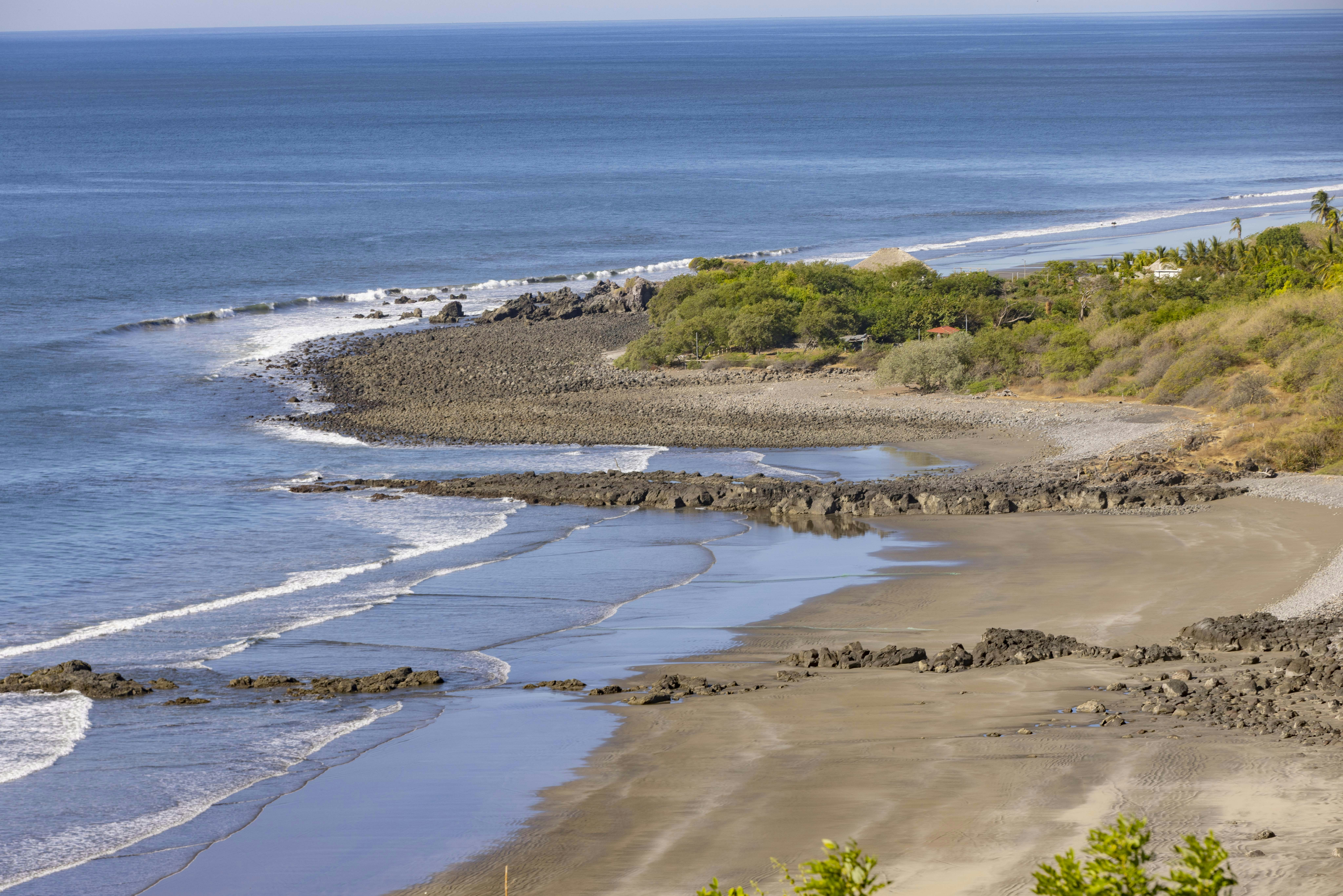 Coastal curve: rocky shoreline meets calm tide