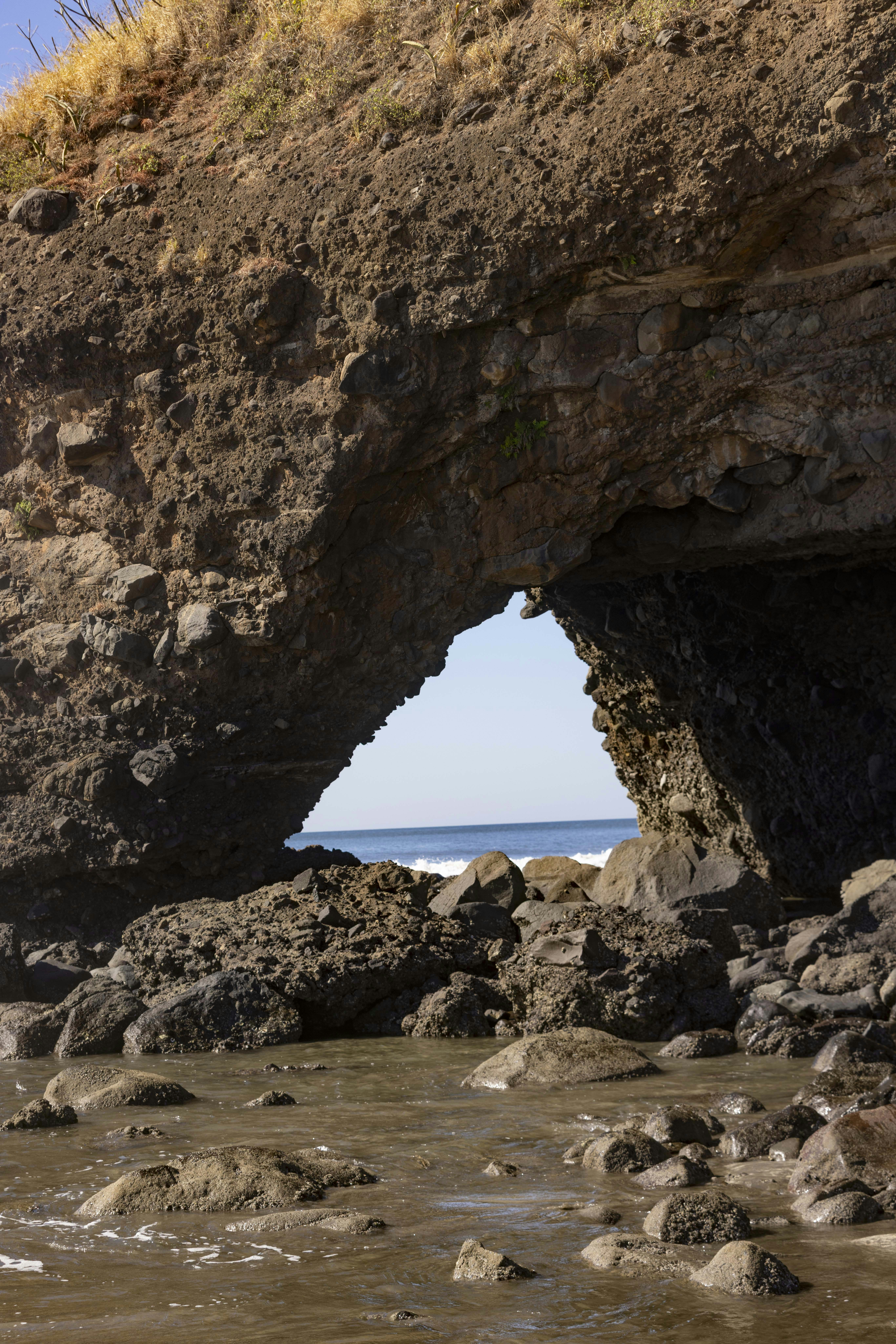 Natural Arch Frame: Ocean Horizon Through a Rocky Cliff Window