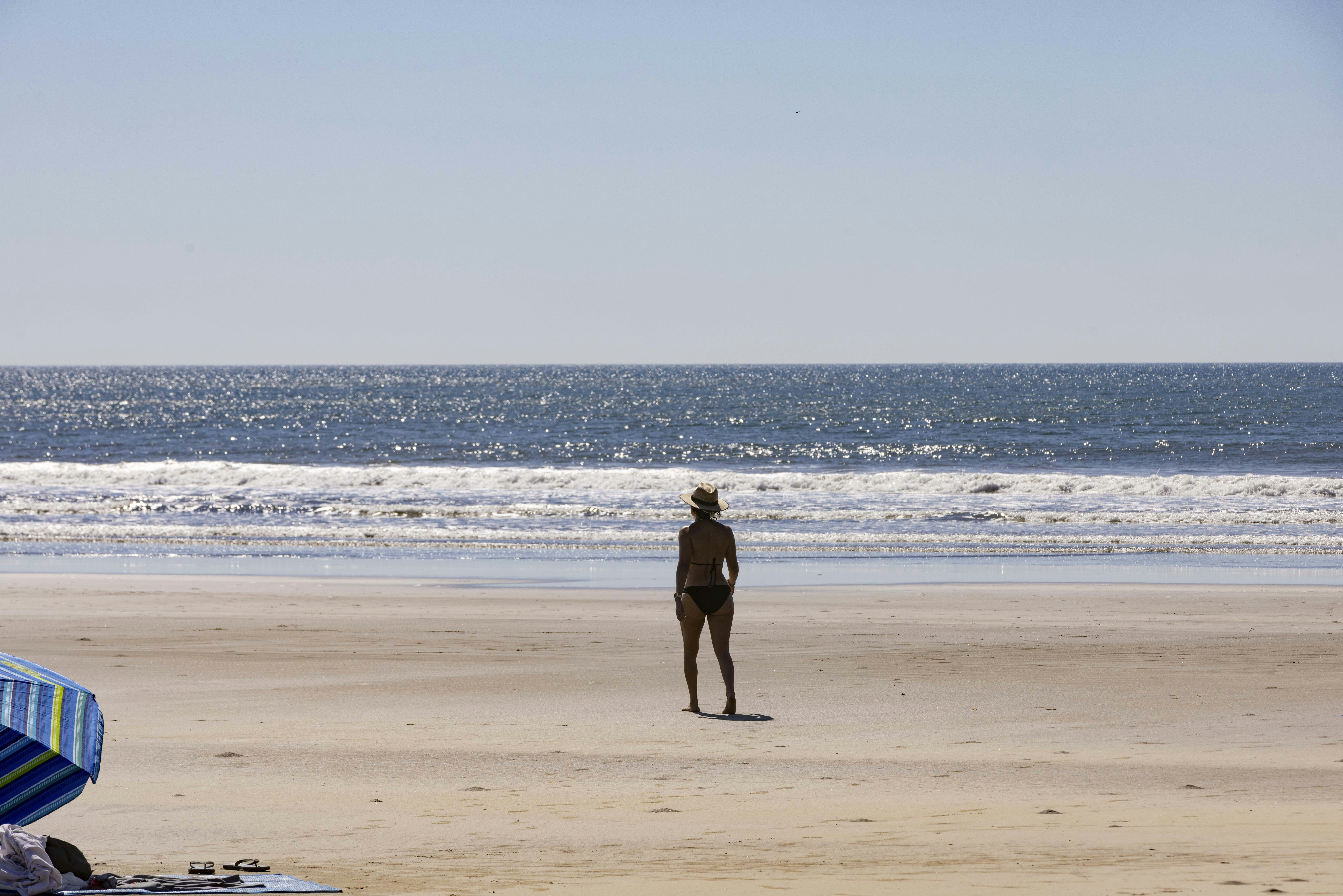  solitary beach silhouette: figure at the waterline