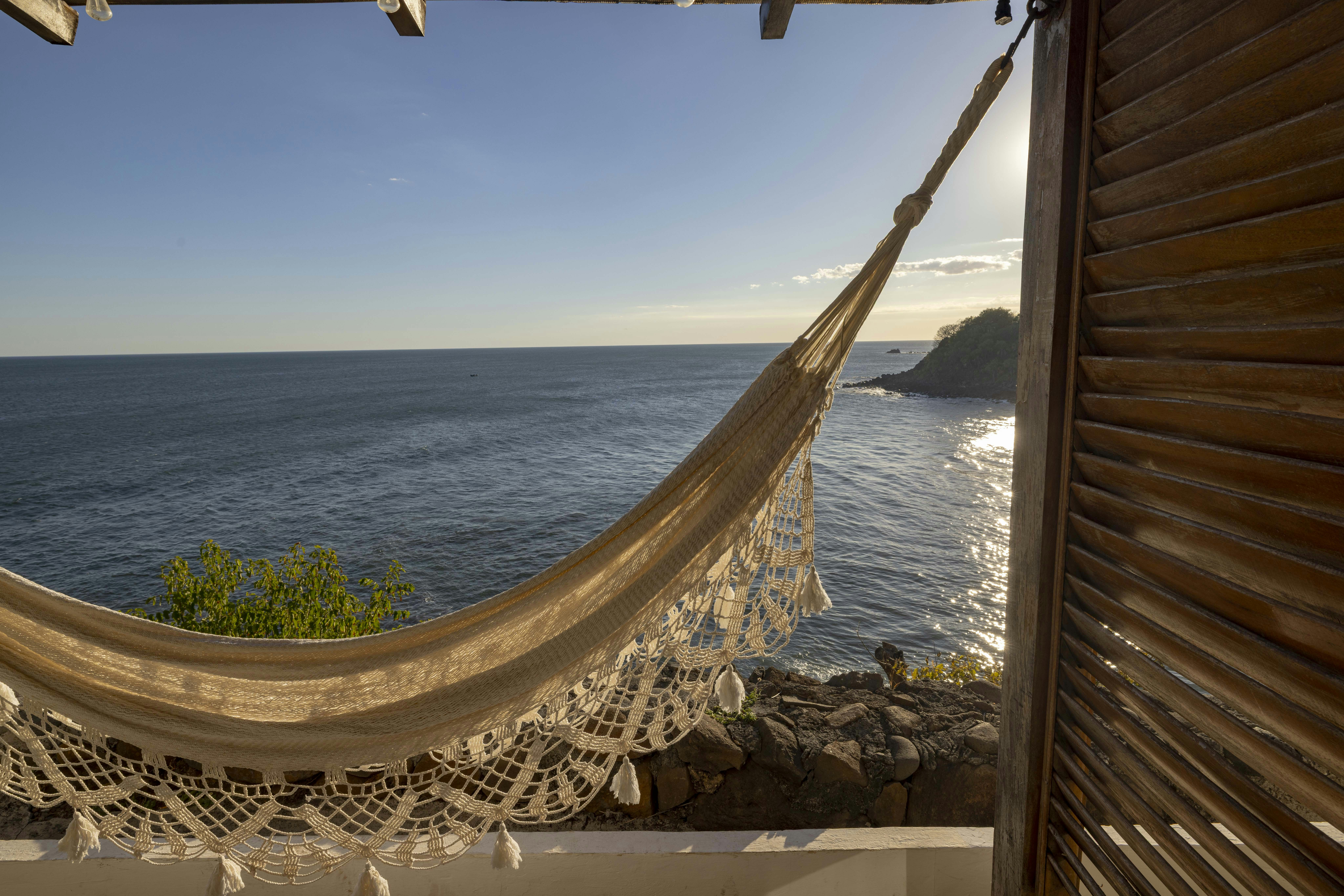 Cradle of Calm: A Hammock Quietly Fringes the Sea