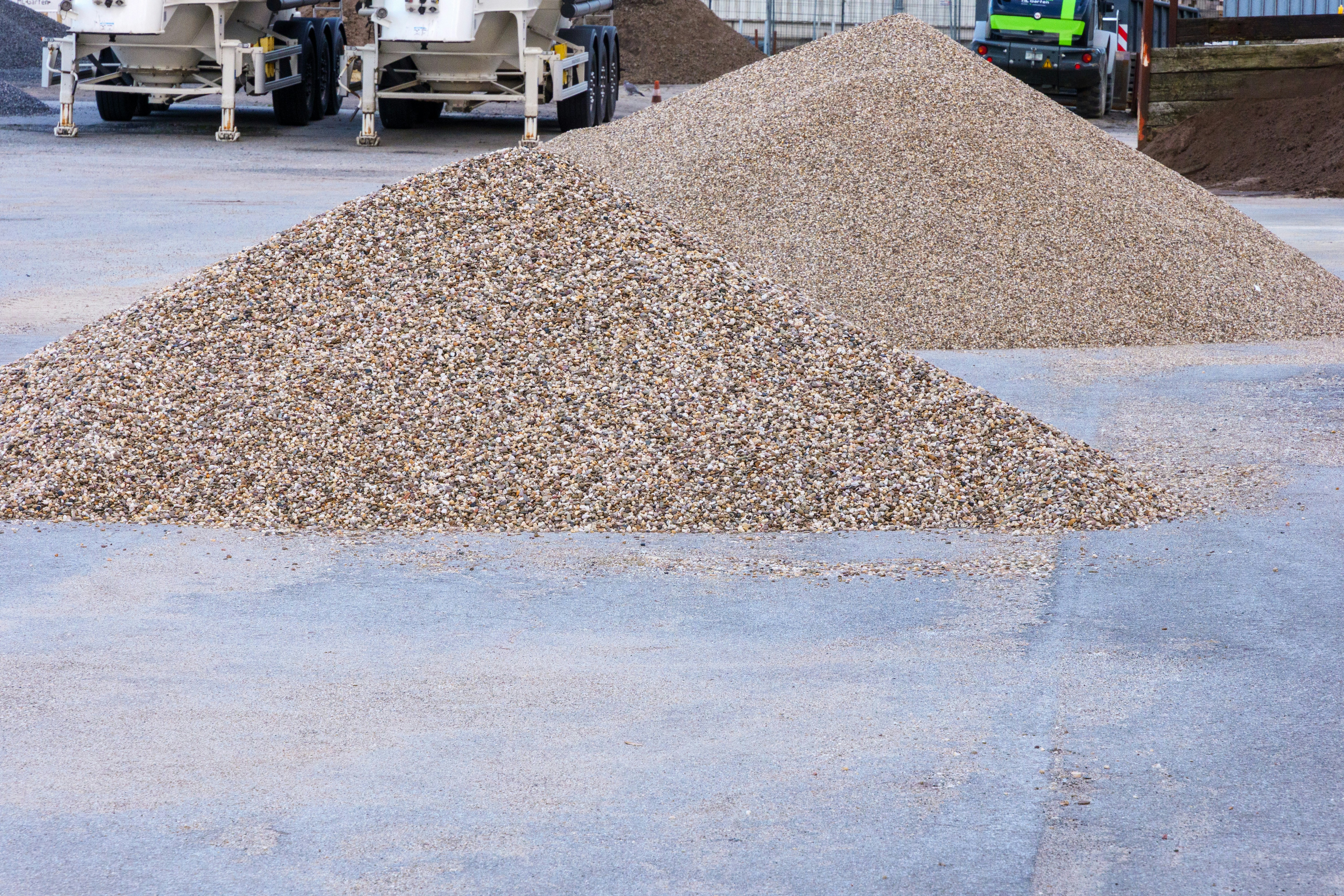Rumbling Piles: Gravel Mounds Under Industrial Equipment