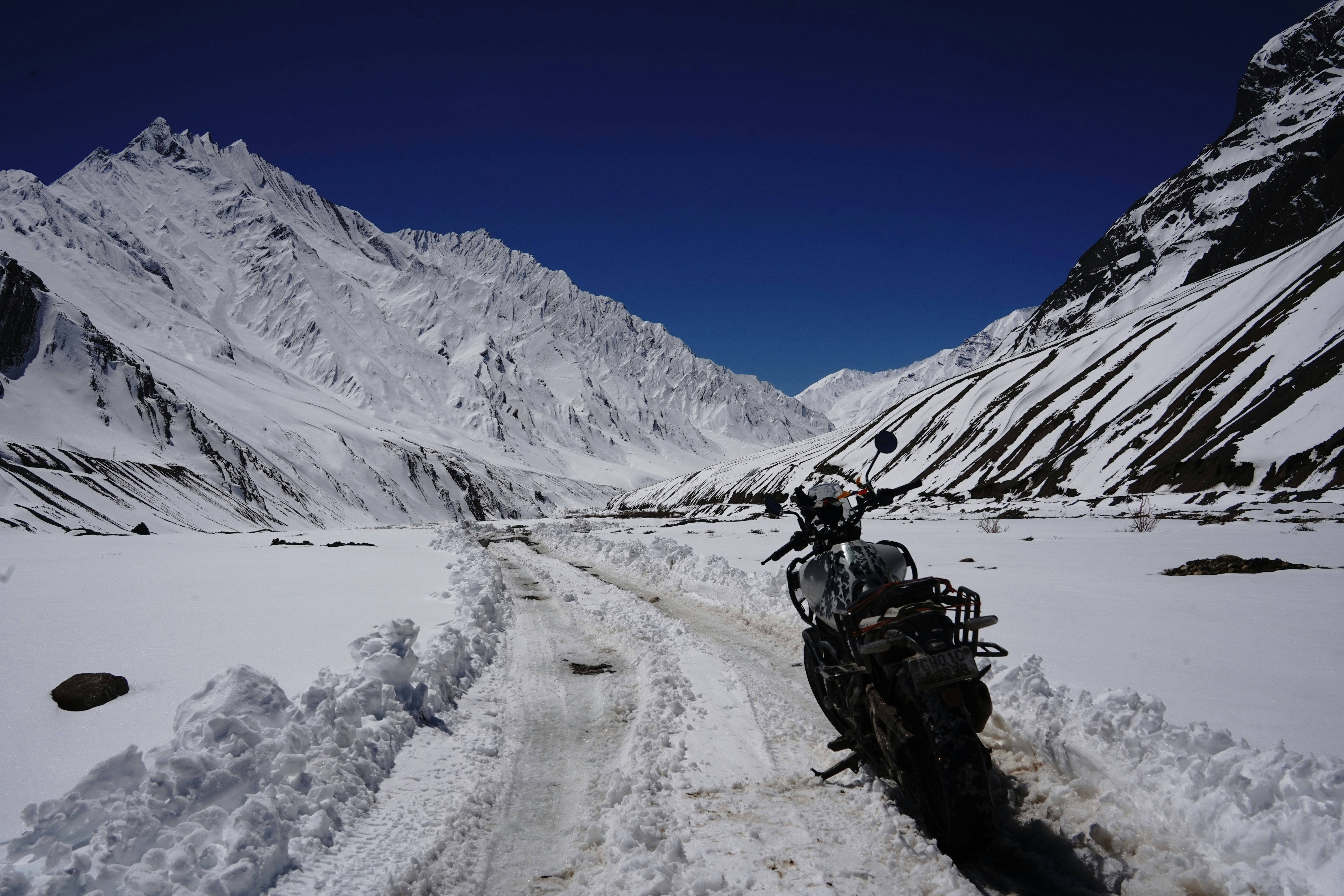 Snowbound Ride: A Rugged Motorcycle Conquers a Glacial Corridor