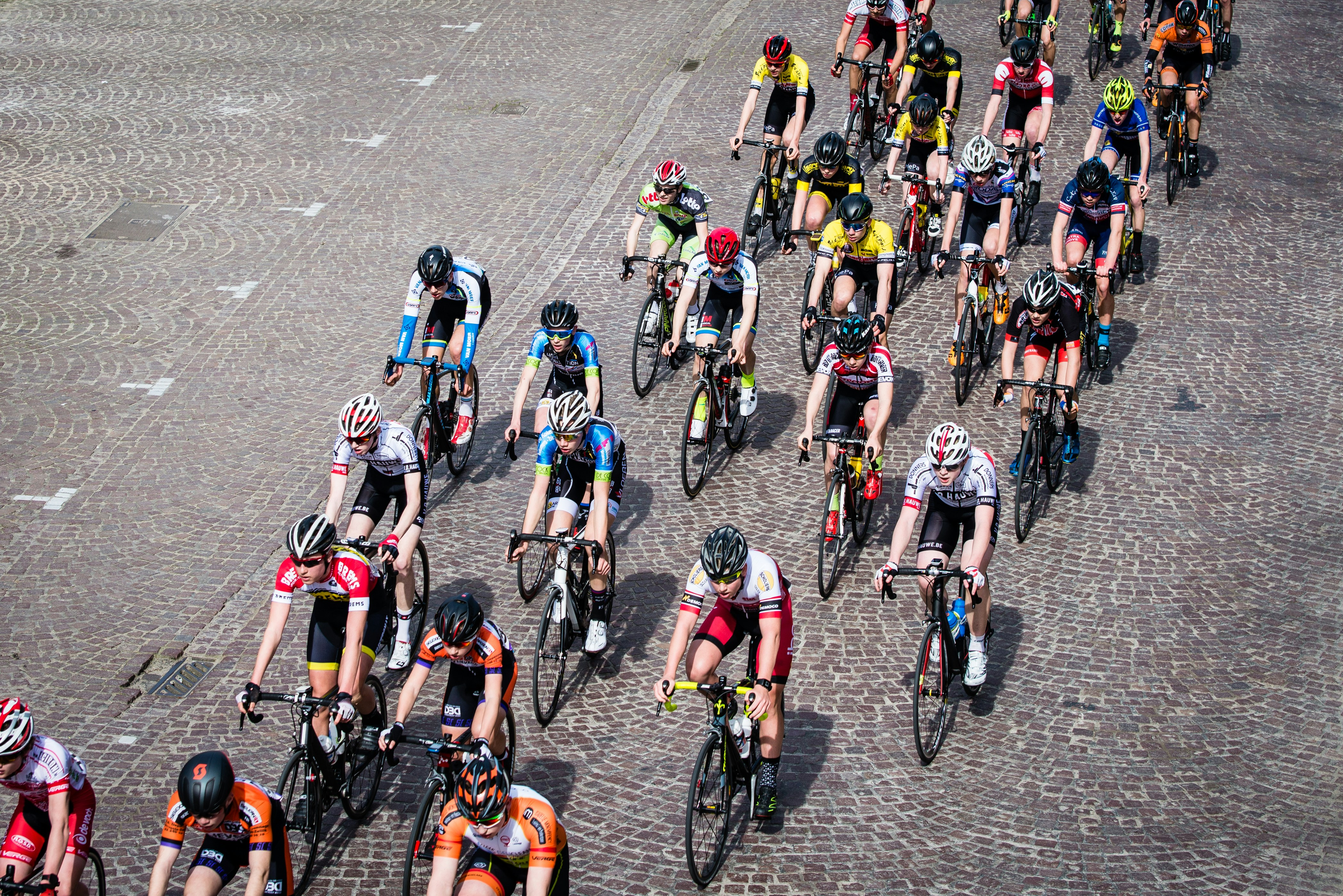 Cycling Pack Racing Through Historic Cobblestones