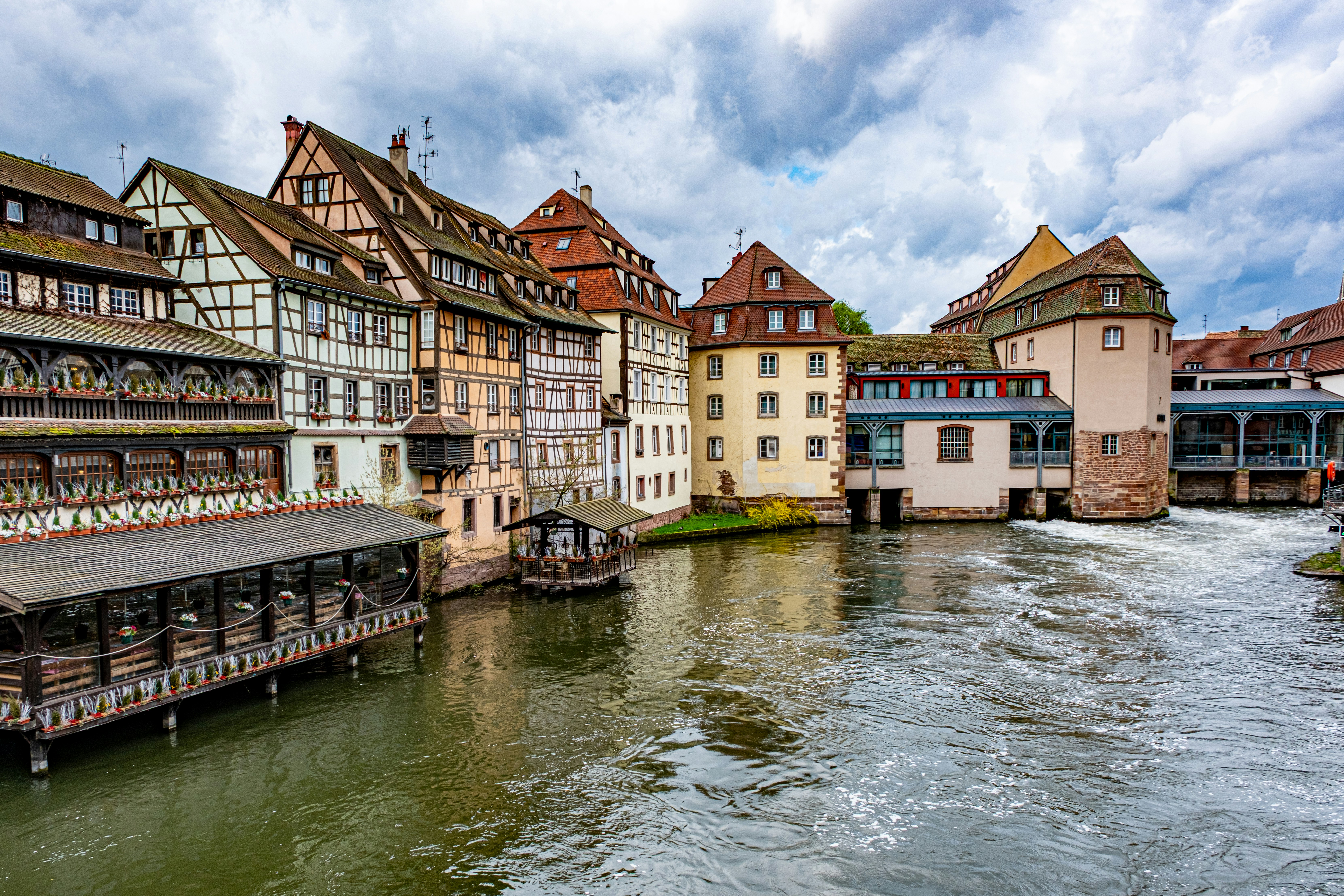 Colorful Fachwerk River Town Under a Patchwork Sky