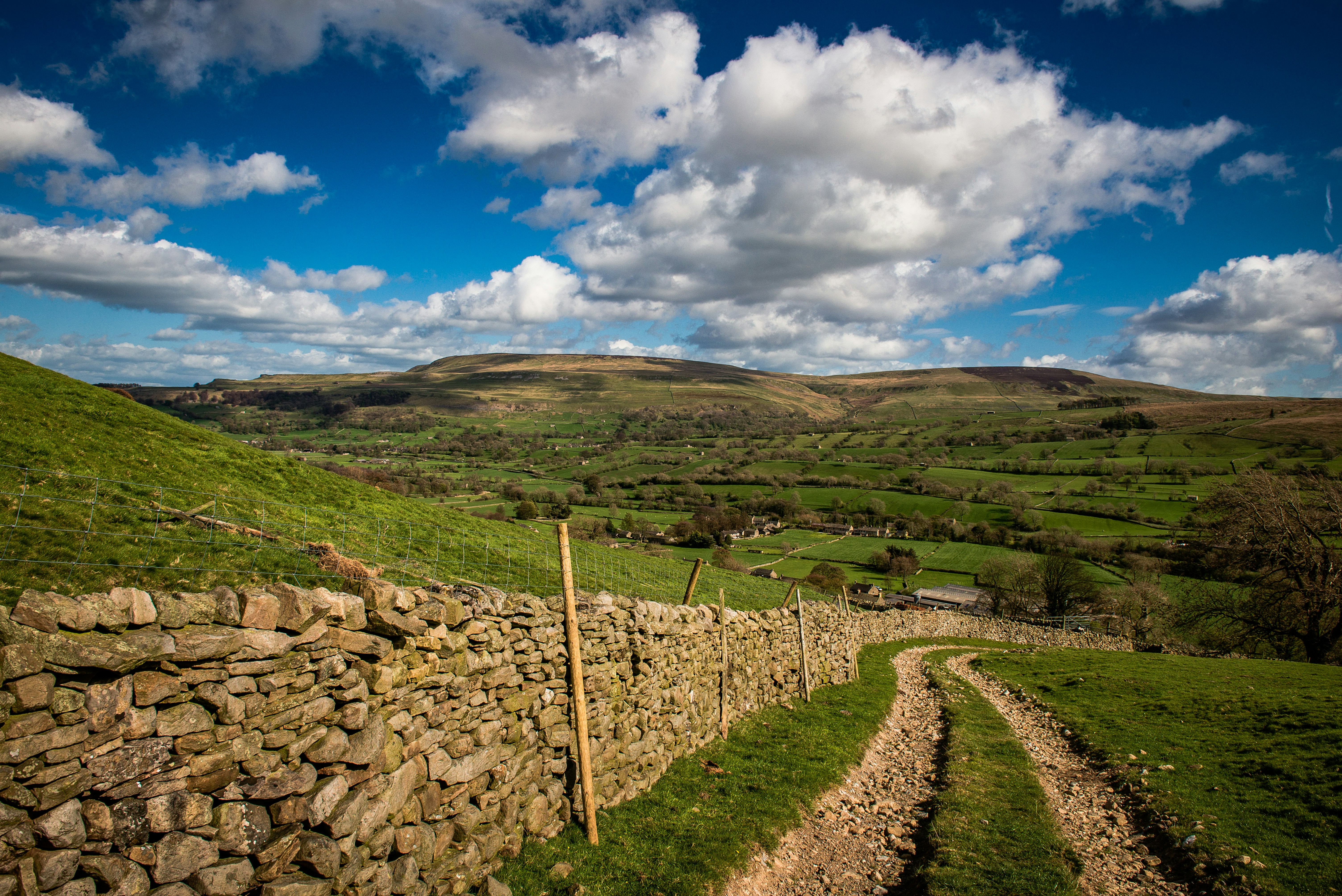 Stone Lane to the Row of Hills Under a Patchwork Sky
