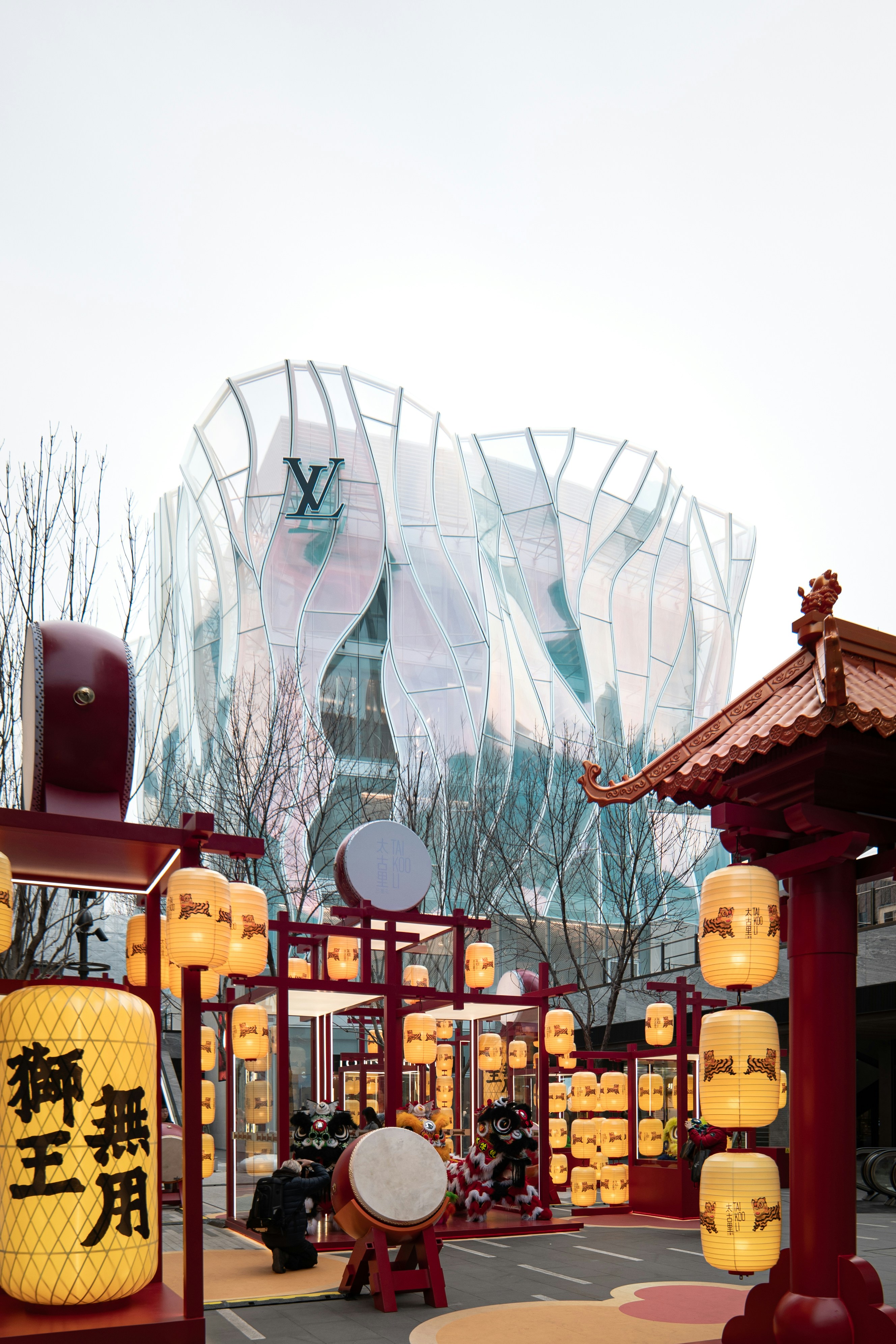 Glass River of Light: The Louis Vuitton Building Framed by Lanterns