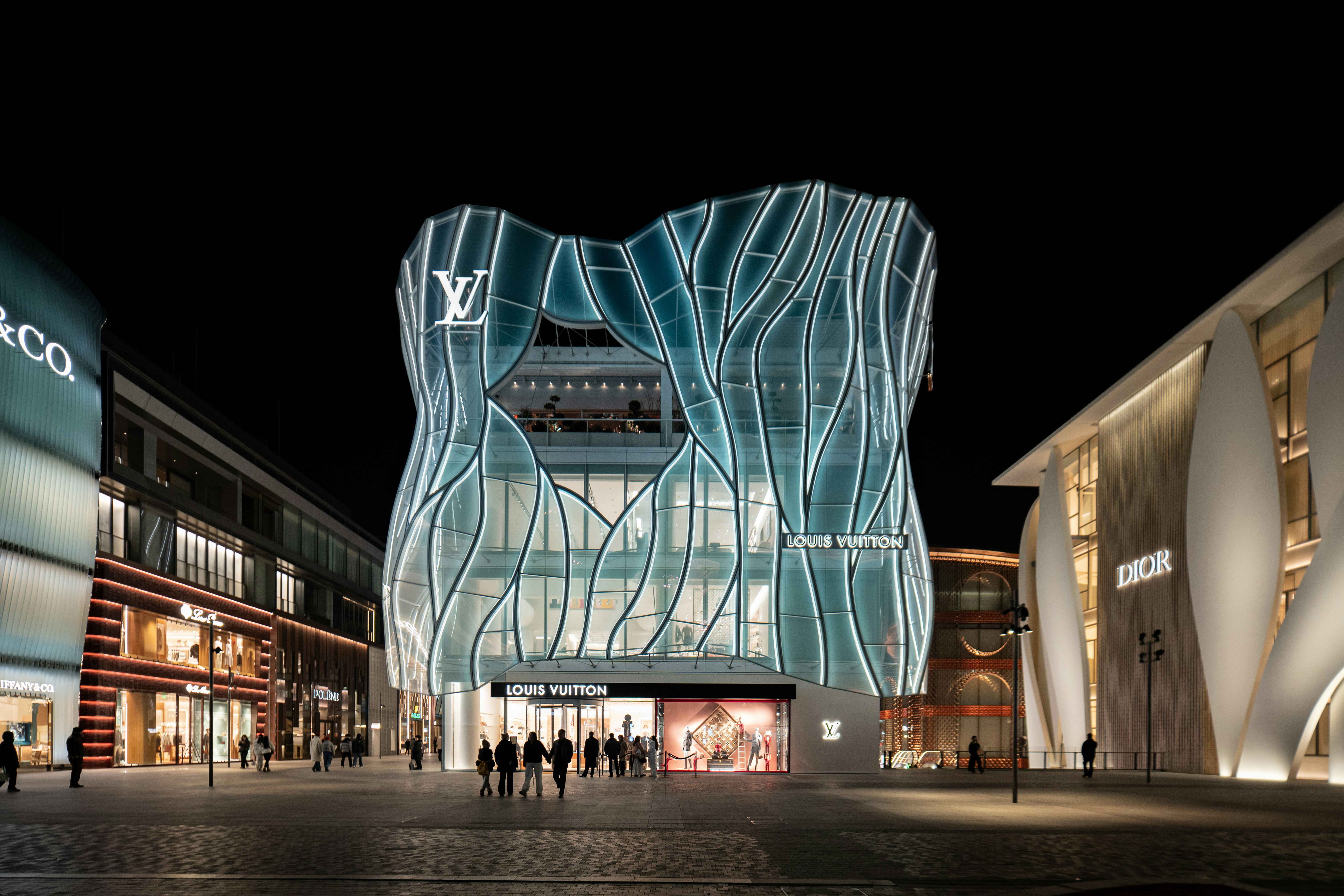 Luminous Luxe: The Curved Facade of a Modern Fashion Nexus