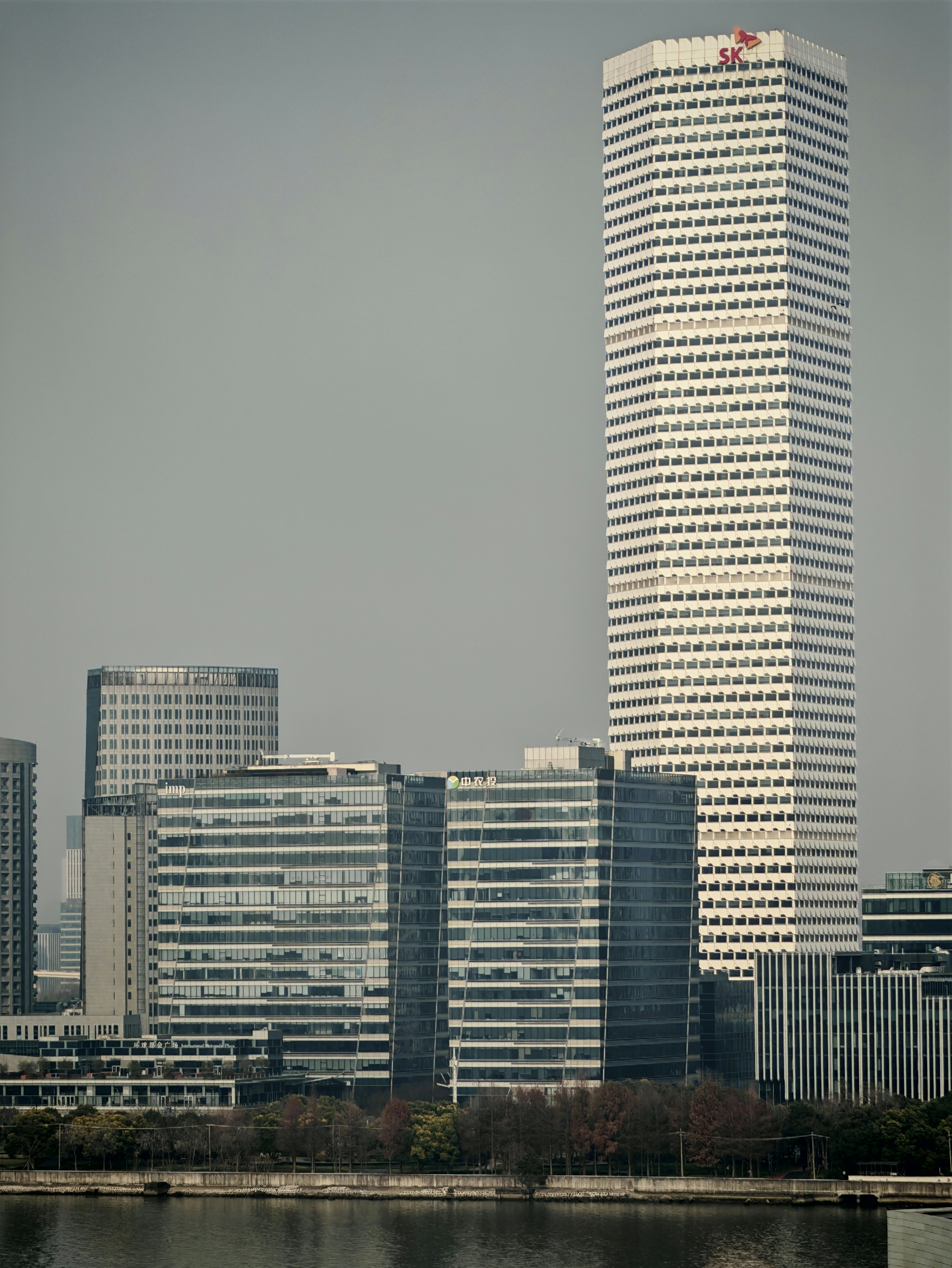 Vertical skyline: a tall office tower dominates the harbor-front silhouette