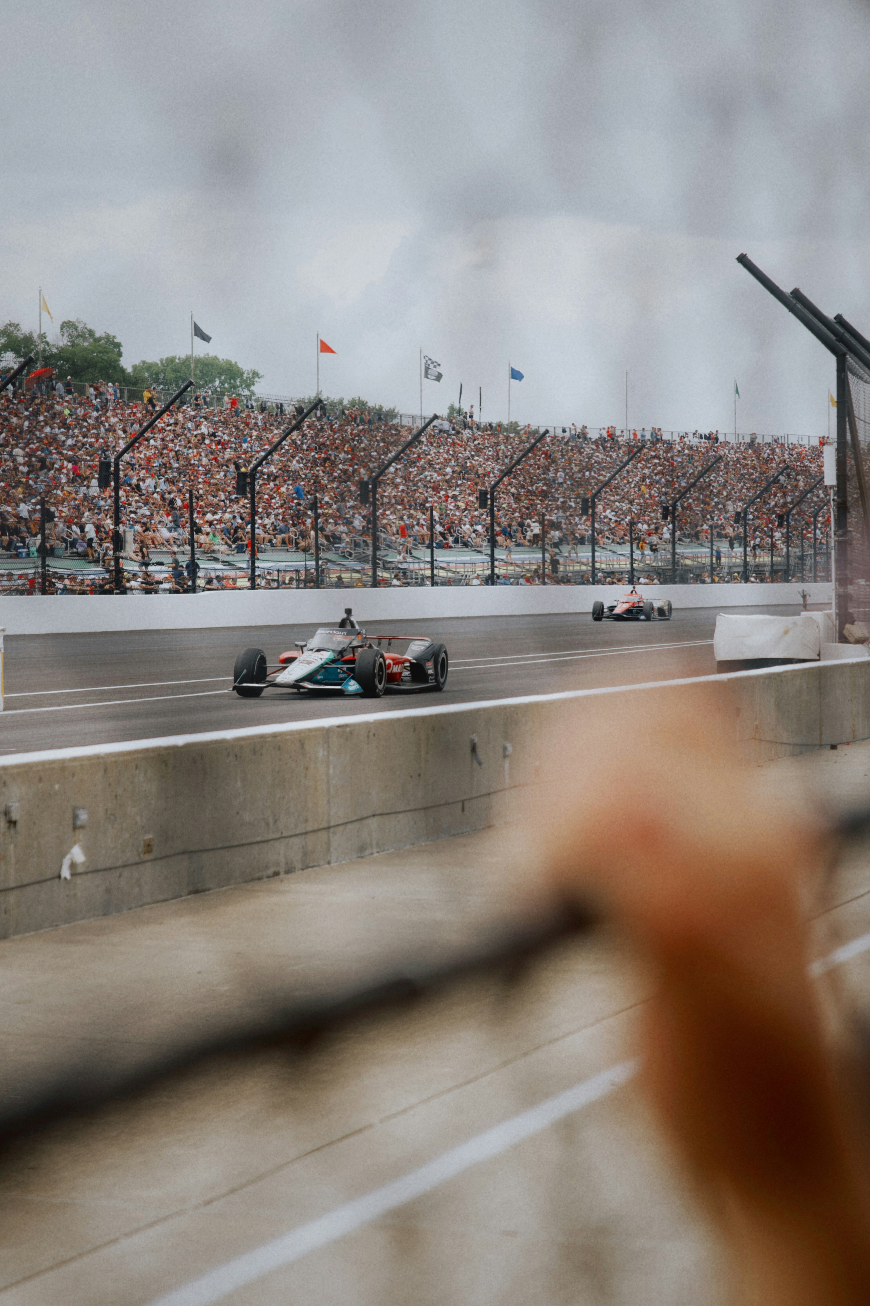 Lead car glides along the near-wall on a crowded grand prix day