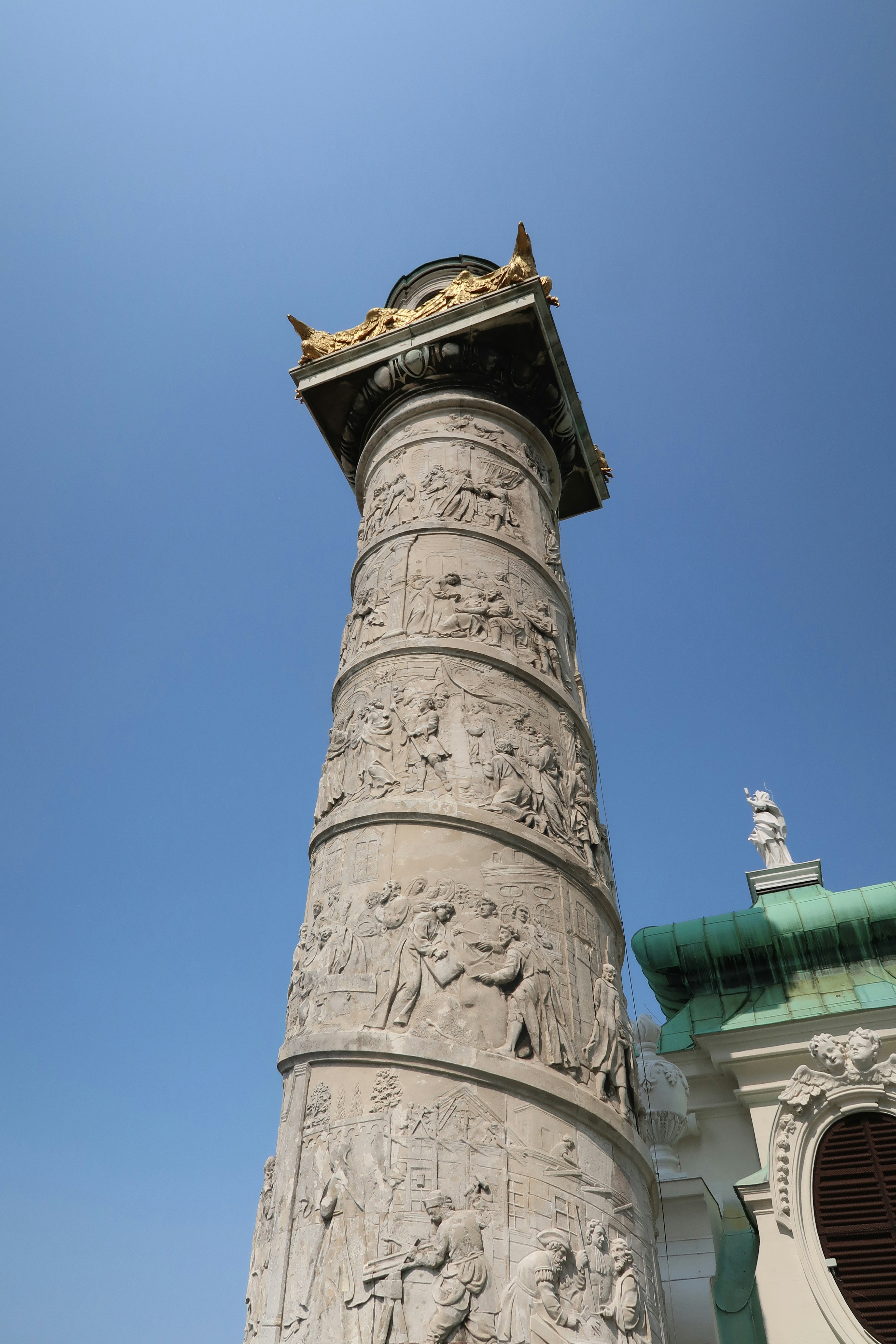 The Spiral Column Ascendant: Carved Chronicle Under a Clear Sky