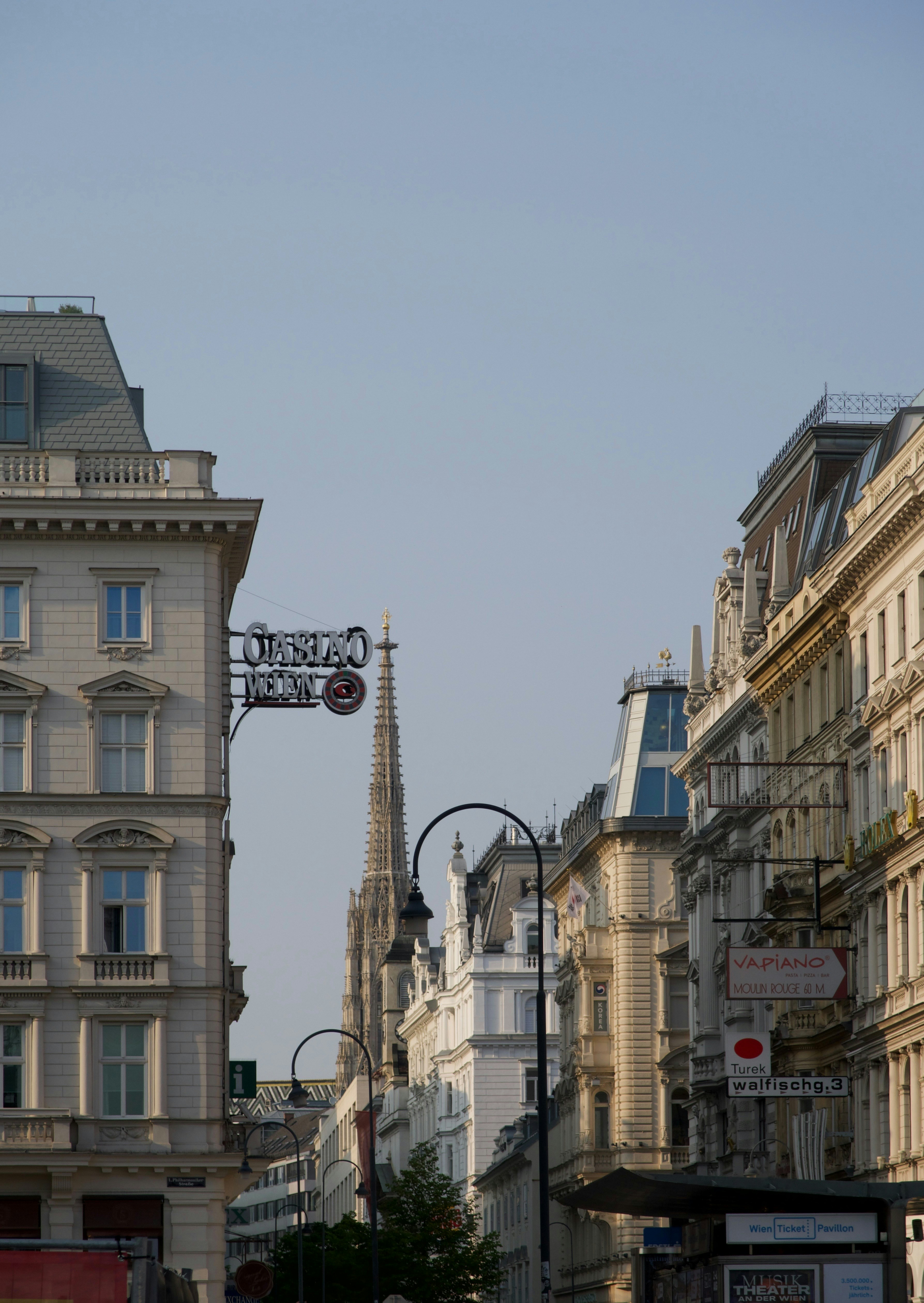 City Street Convergence: Spire, Signage, and Historic Facades
