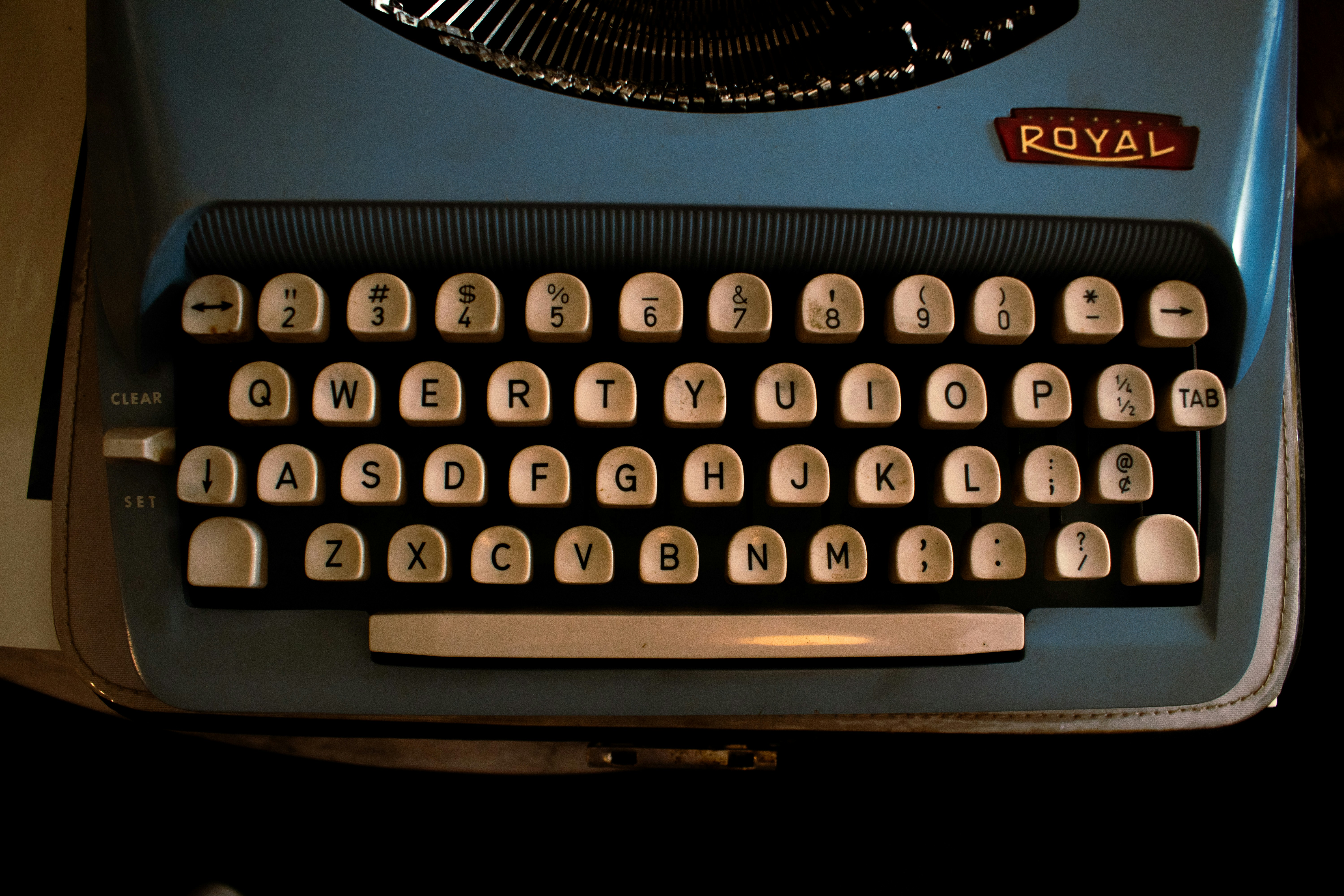 Blue Royalities: A Vintage Typewriter’s Keyboard Reclines in Low Light