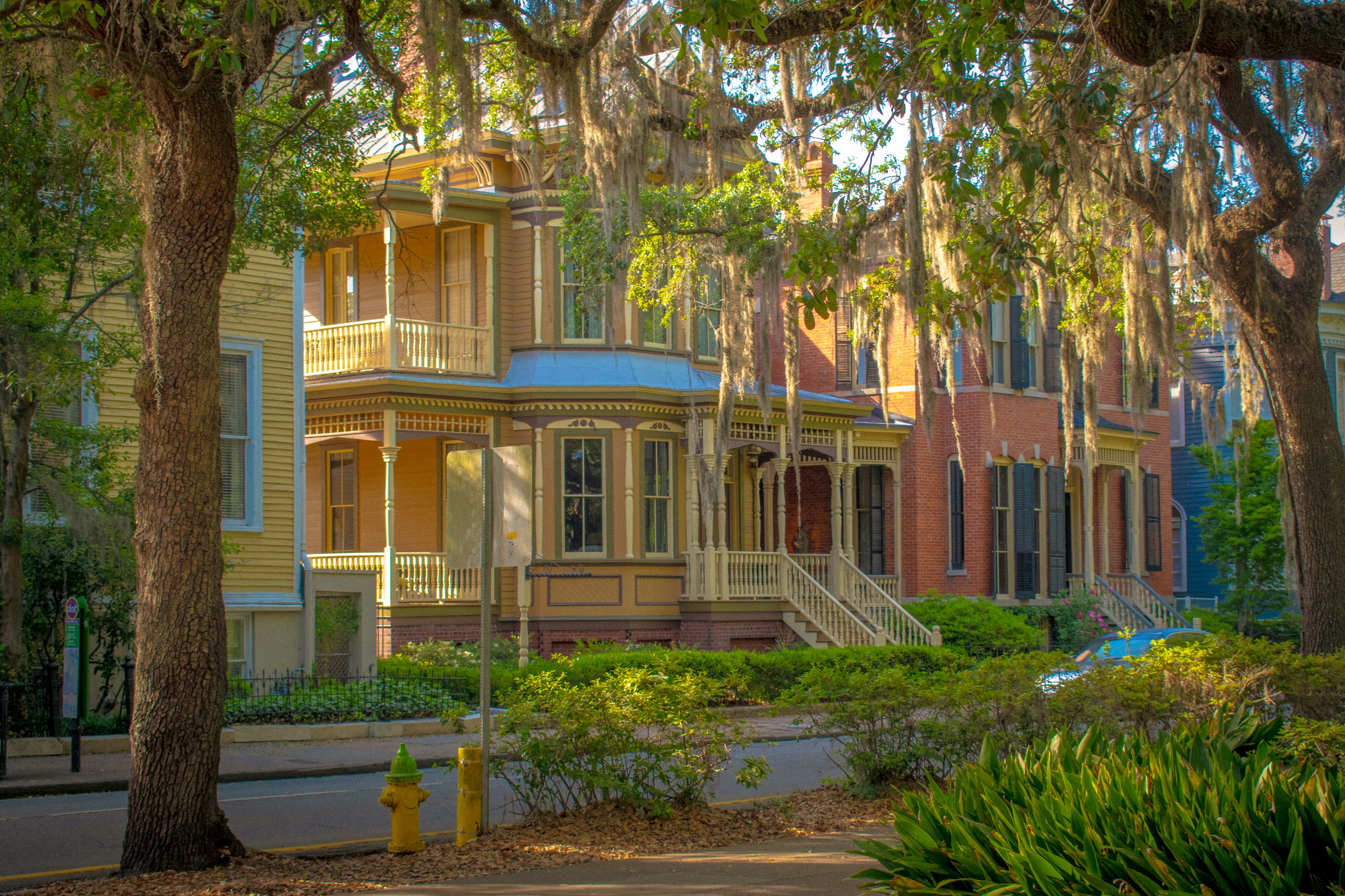 Sunlit Victorian Row: Quiet Street, Vibrant Facades