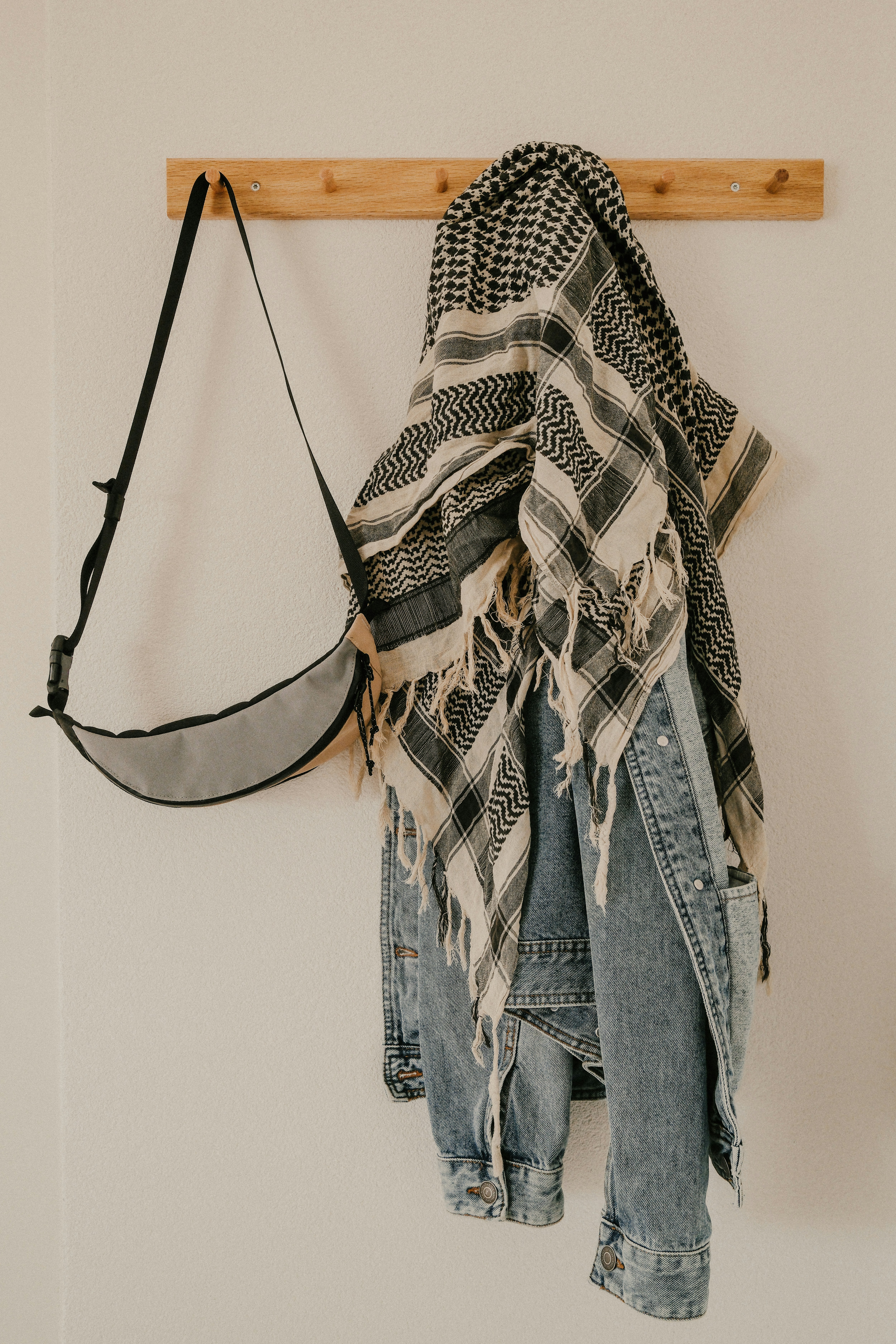 Hanging scarf and denim jacket: a minimalist entryway vignette