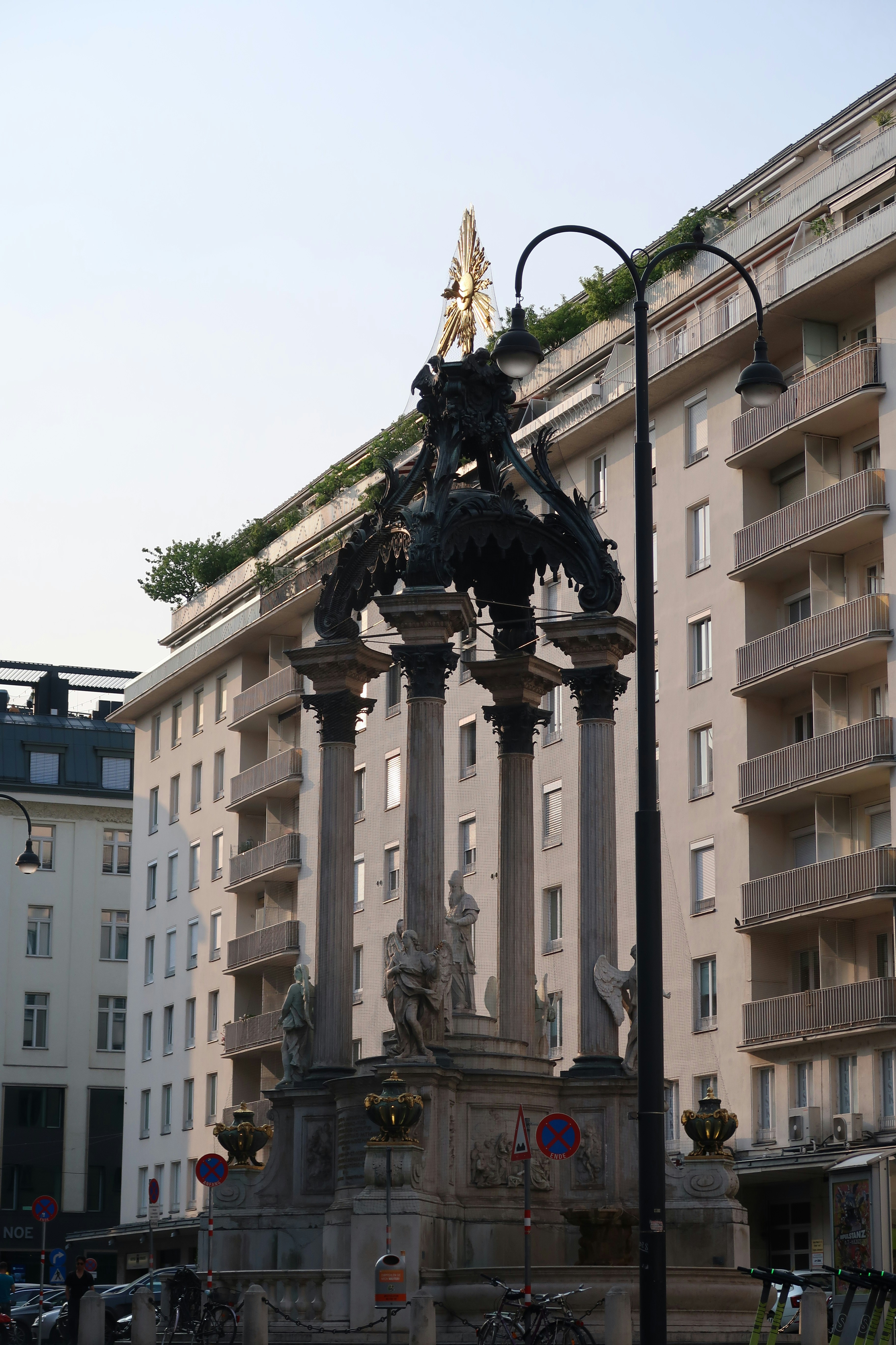 Ornate monument framed by urbanگرد skyline and arched lampposts