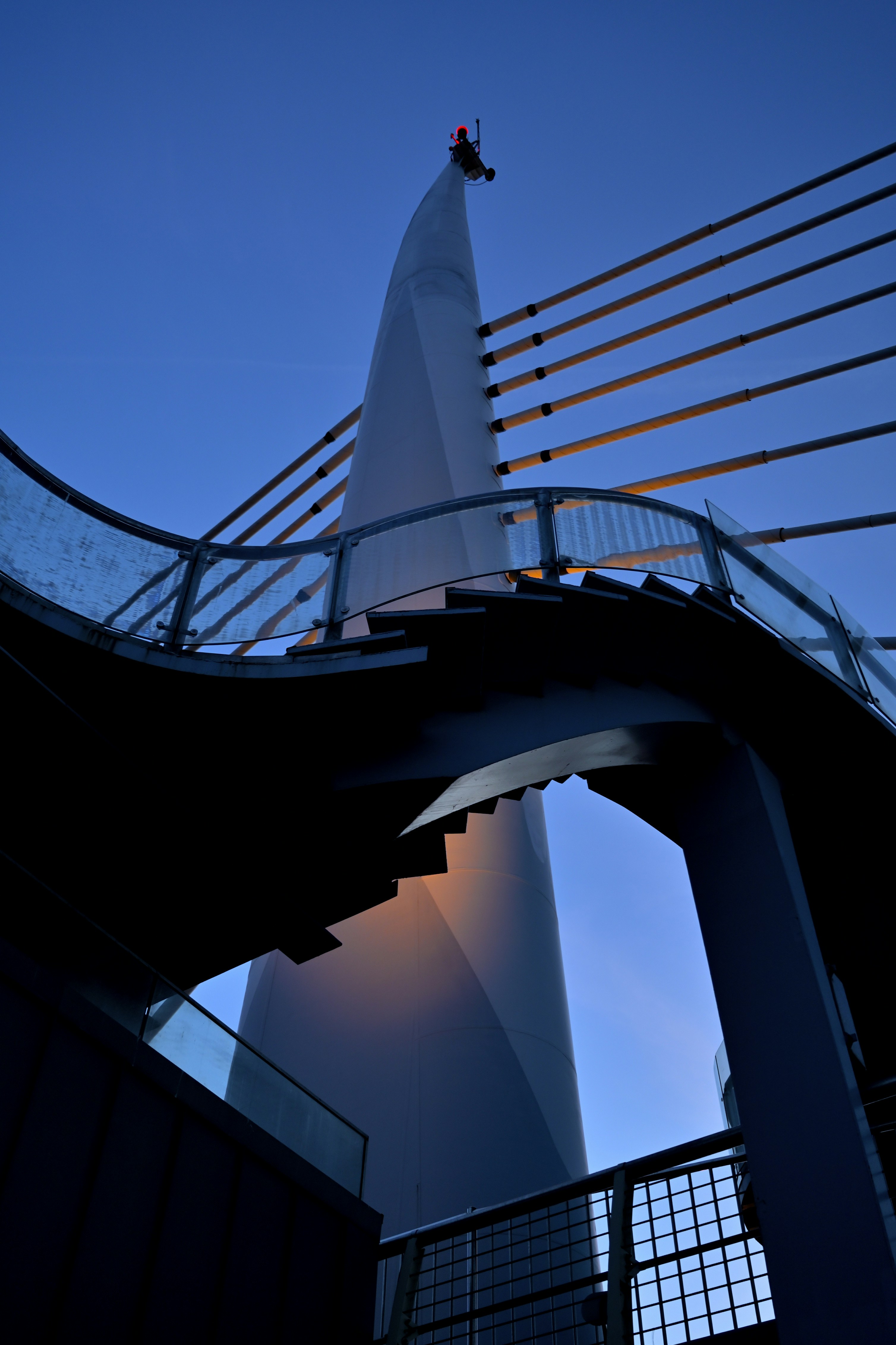 Ascendant Spine: A Towering Curve Against a Blue Sky