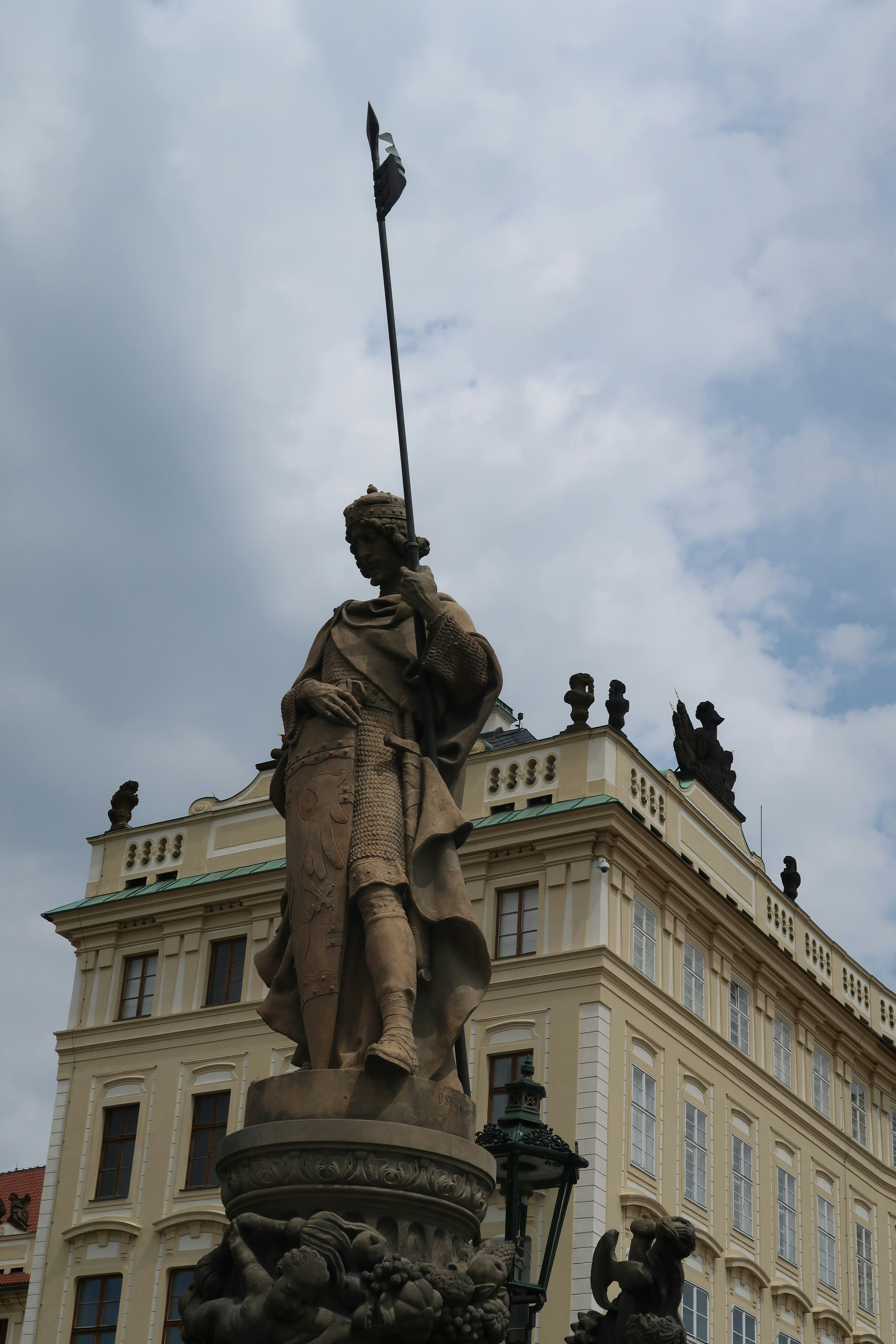 Statue Guarding the City: A Heroic Figure Overlooking the Classical Facade