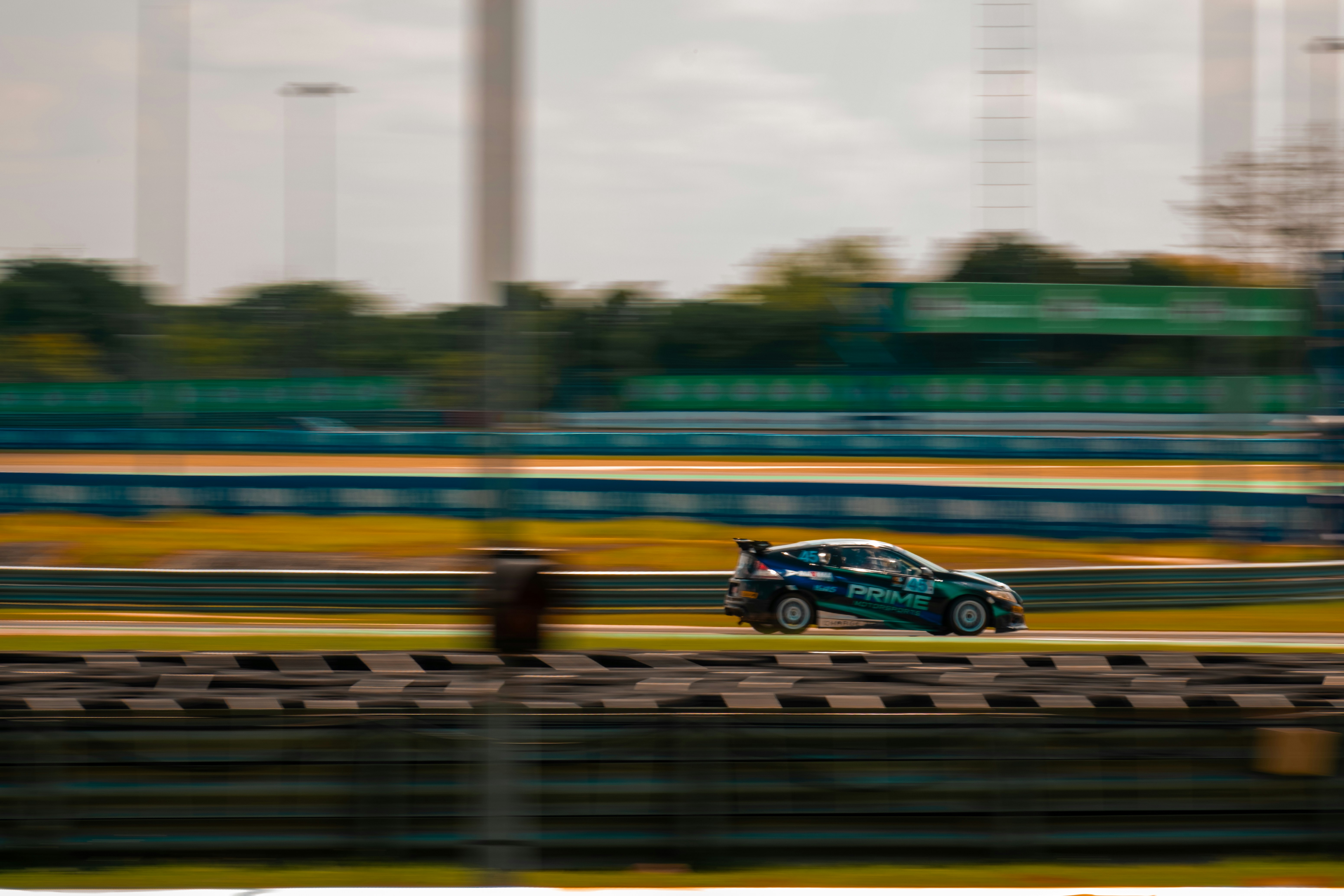 High-speed silhouette: a race car slicing through a motion-blurred track
