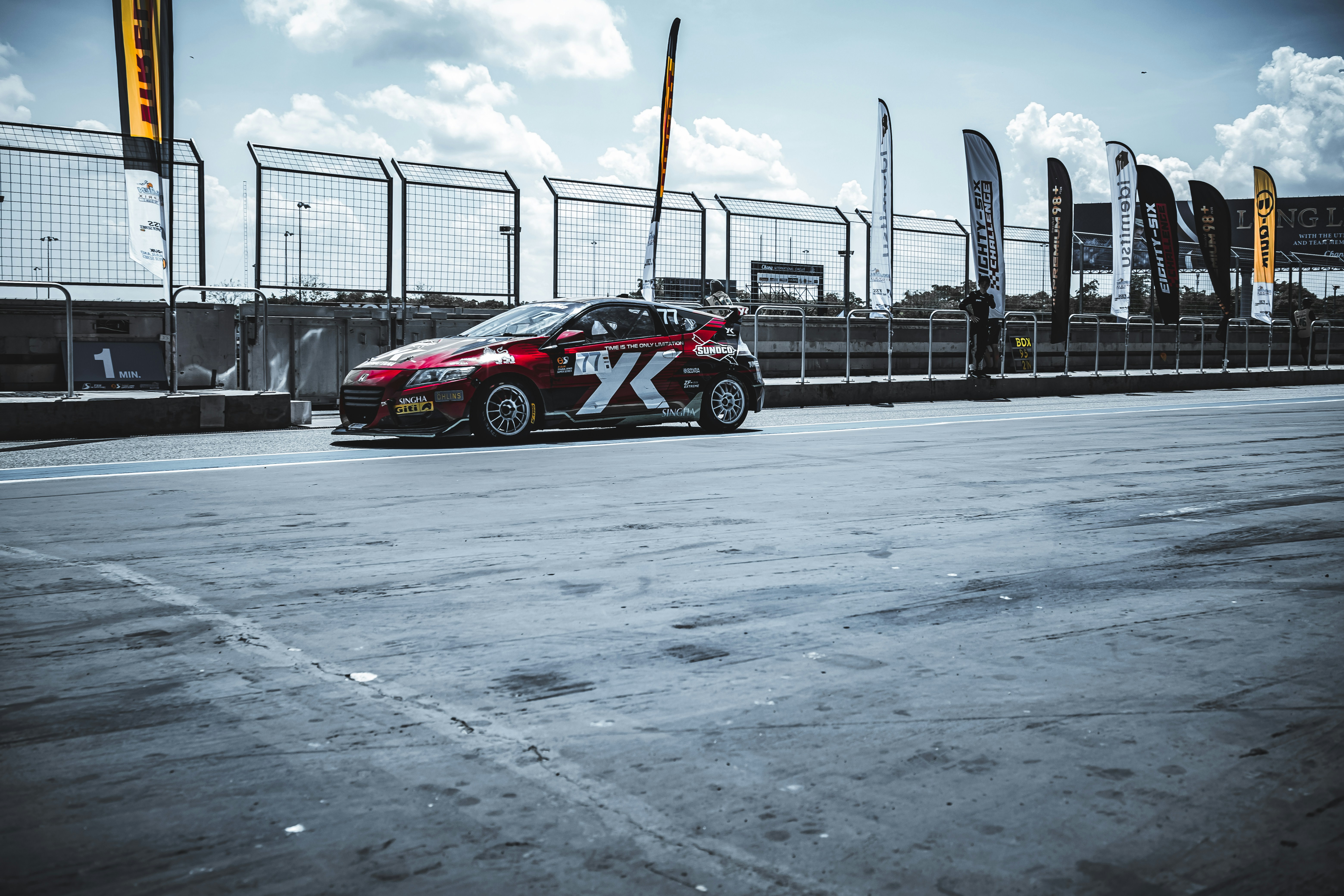Racecar at the Grid: A Red-Streaked Challenger on an Industrial Track