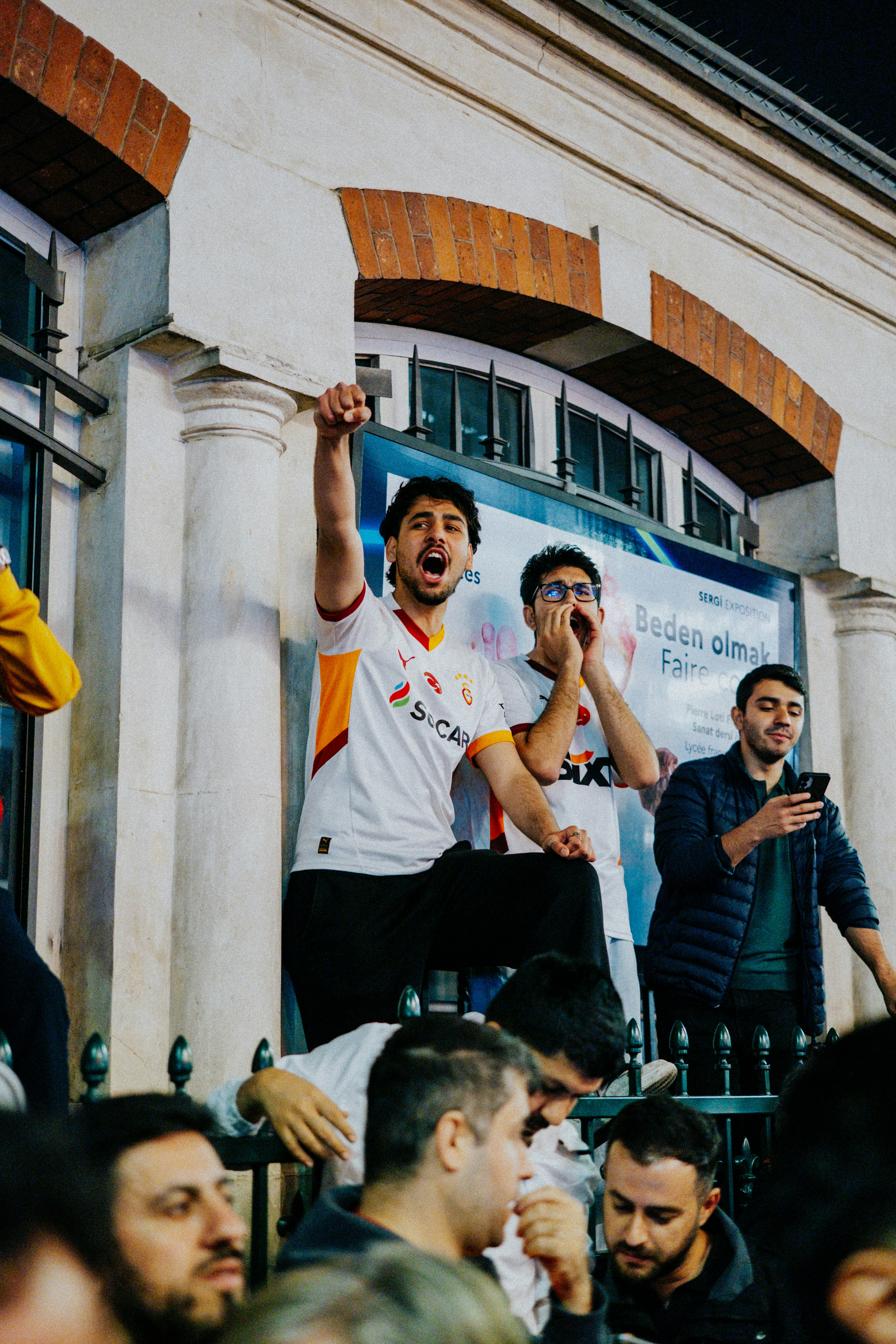 Cheering Crowd on a City Street: A Moment of Shared Victory