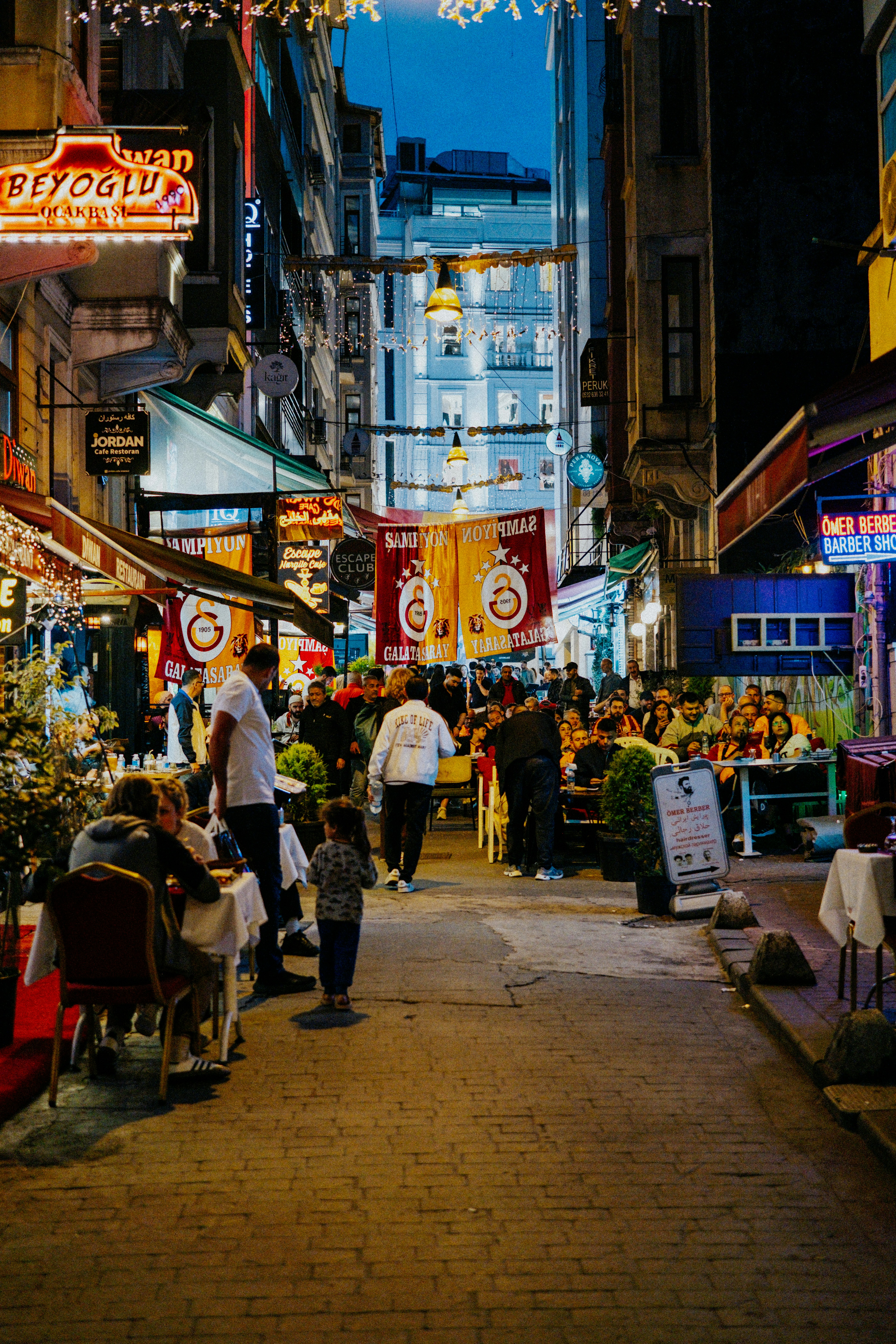 Neon Alley Dinner: A lively lantern-lit street scene full of diners and banners
