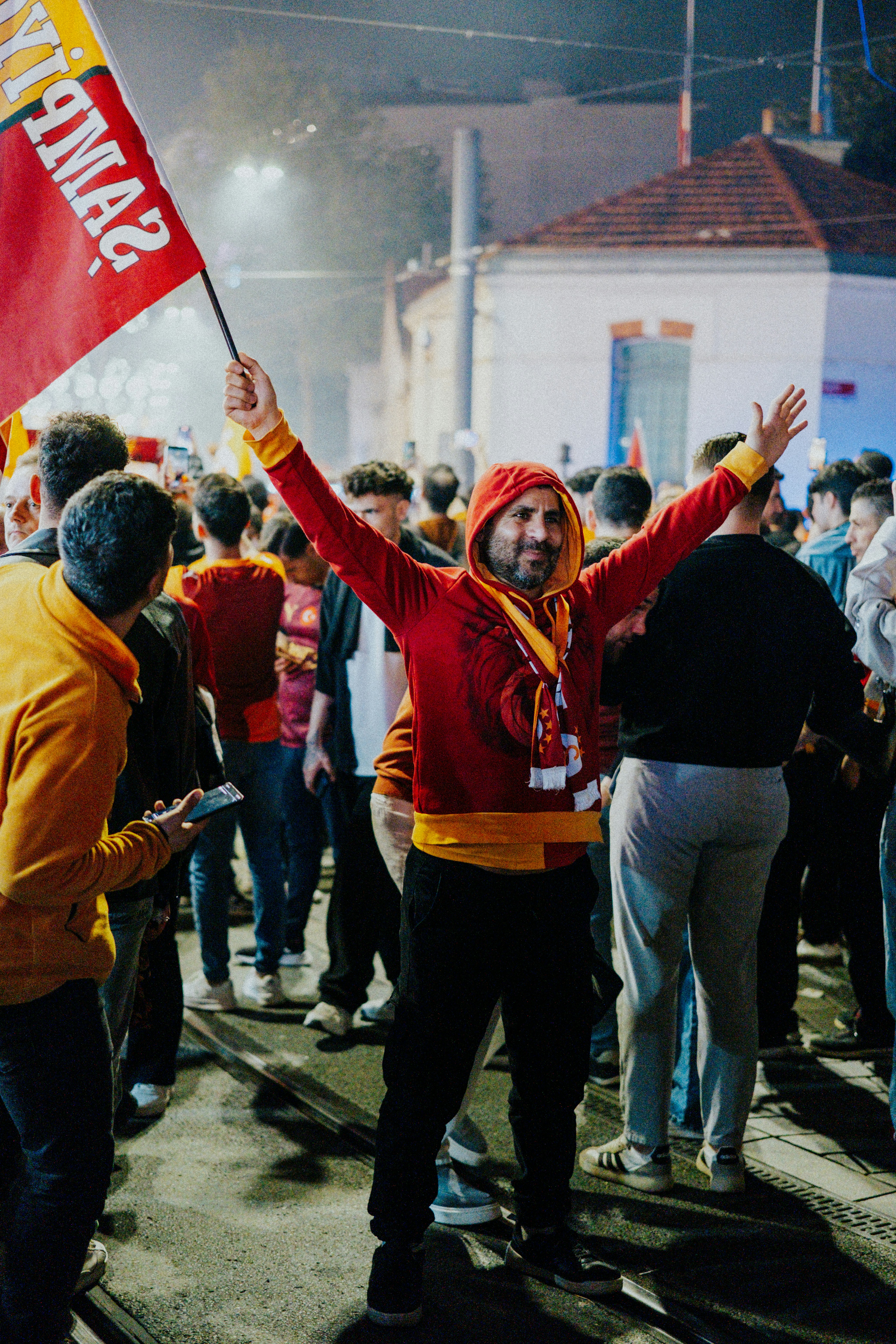 Raising a Flag at Night: A Player Leads the Crowd