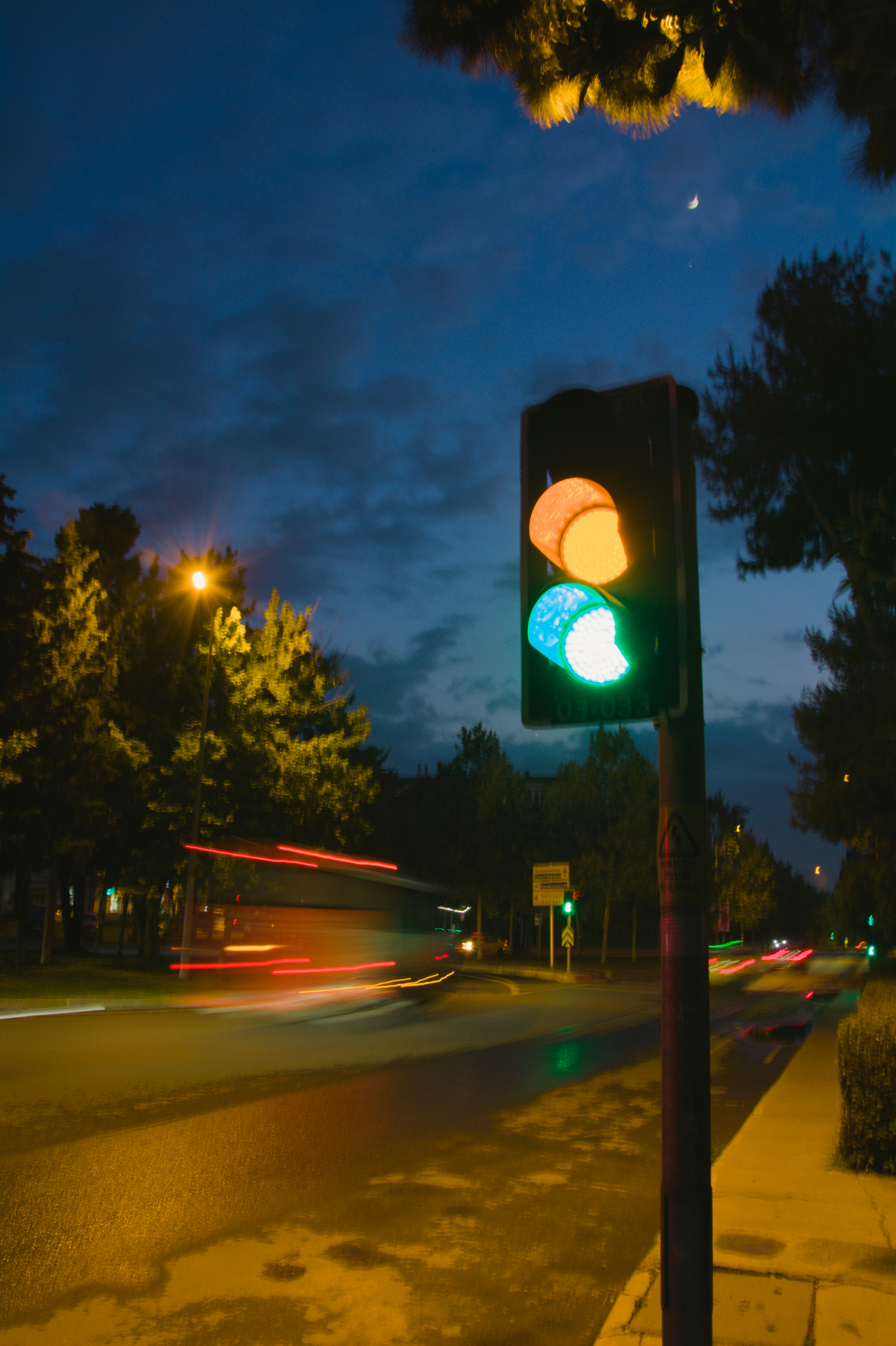 Glowing Green Mercy: A Night-Time Street Signal Over the Quiet Avenue