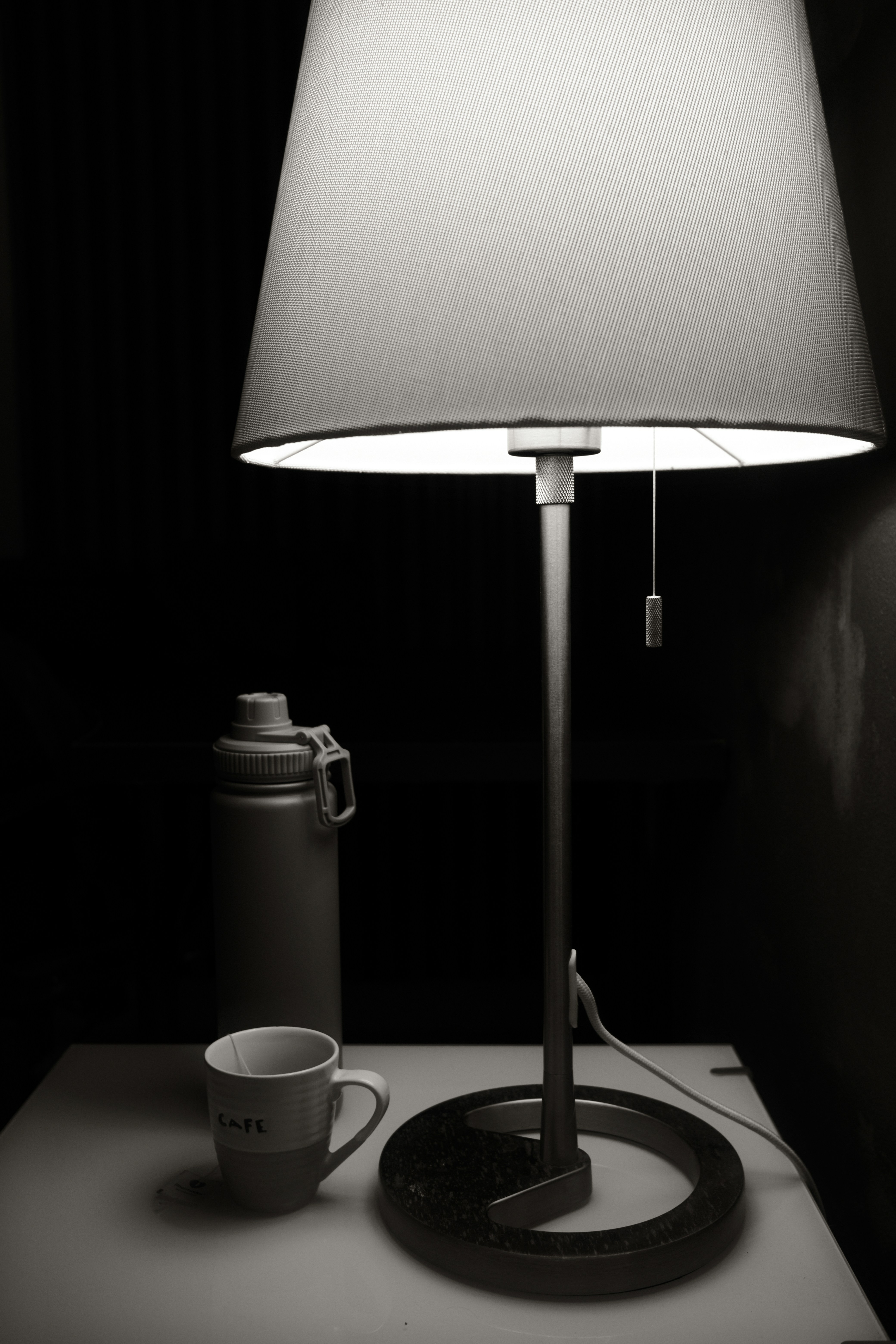 Luminous Shade: A Quiet Still Life with Lamp, Cup, and Kettle